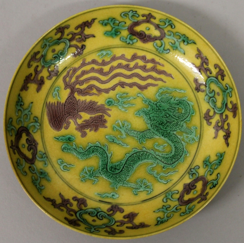 A CHINESE ENAMELLED DRAGON & PHOENIX SAUCER DISH, decorated in green ...
