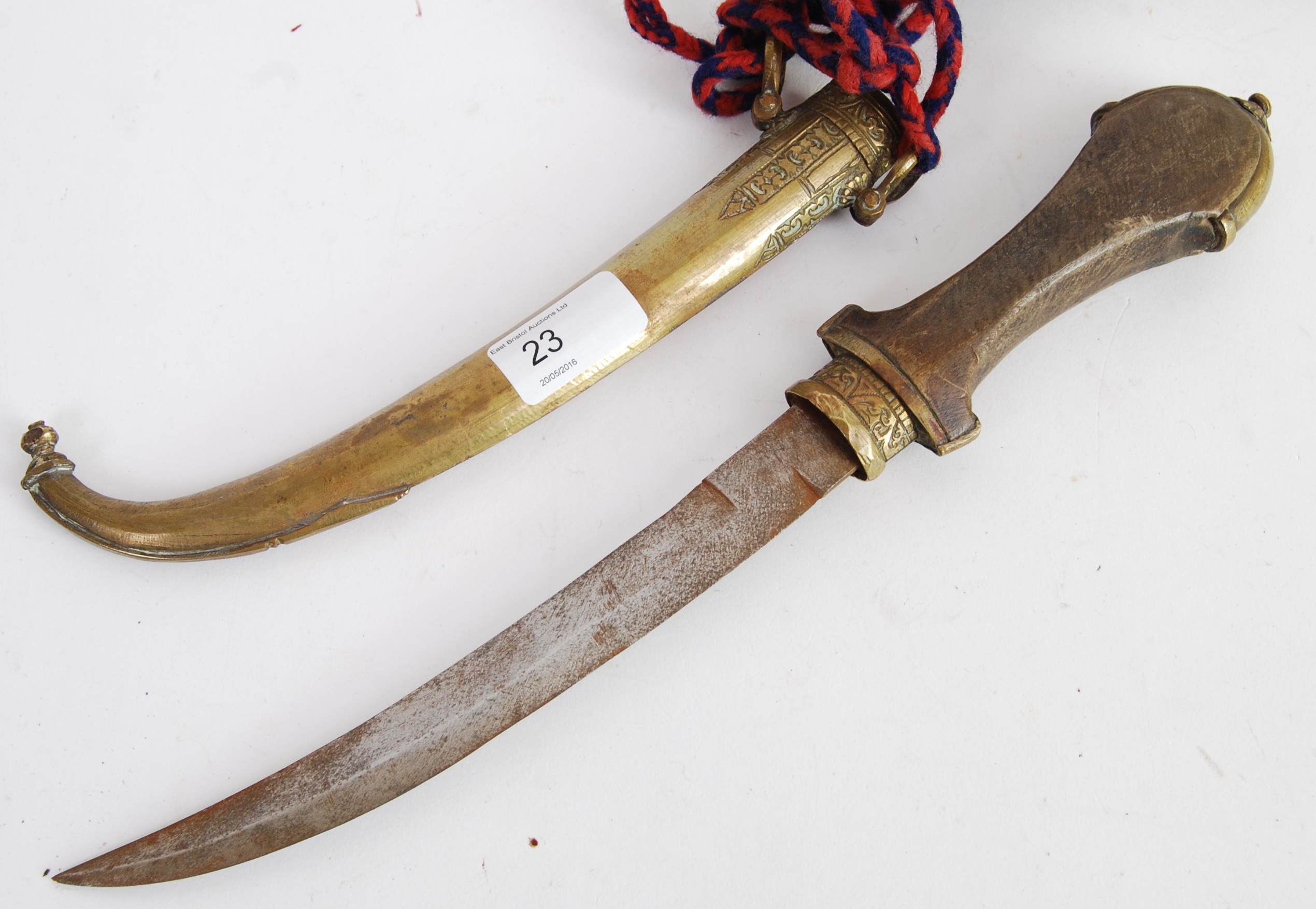 DAGGER; An Indian brass curved blade dagger, with brass scabbard, and ...