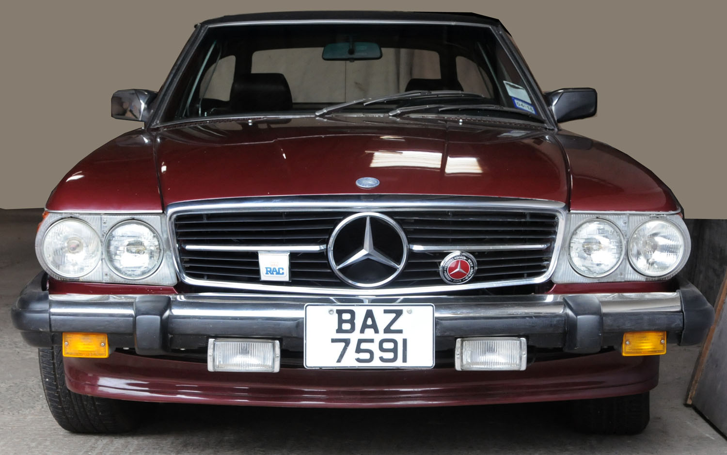A Mercedes Benz 560SL (Model R107), maroon, soft top two seat sports ...
