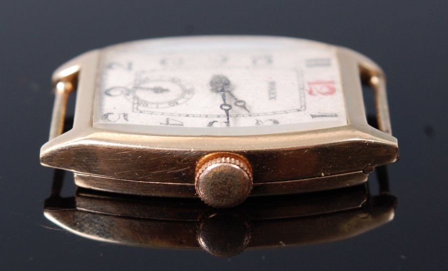 A vintage gents 9ct gold Rolex tank watch, having a signed silvered ...