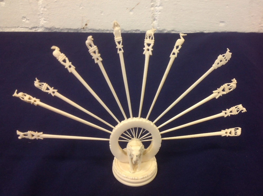 An Indian ivory toothpick holder, modelled as an elephant enclosed by ...