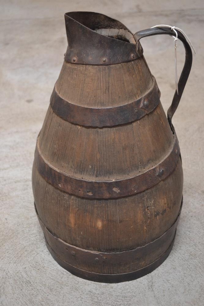 An old cooper made wooden water jug