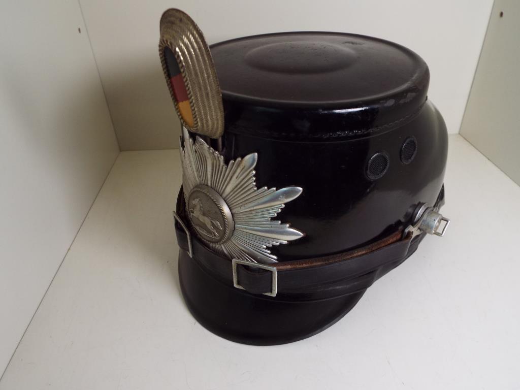 A German Police Shako of the Weimar period, black leather helmet with ...