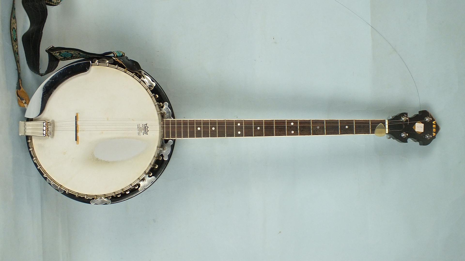 A four-string banjo with 'Remo Weather King' banjo head, 95cm overall ...