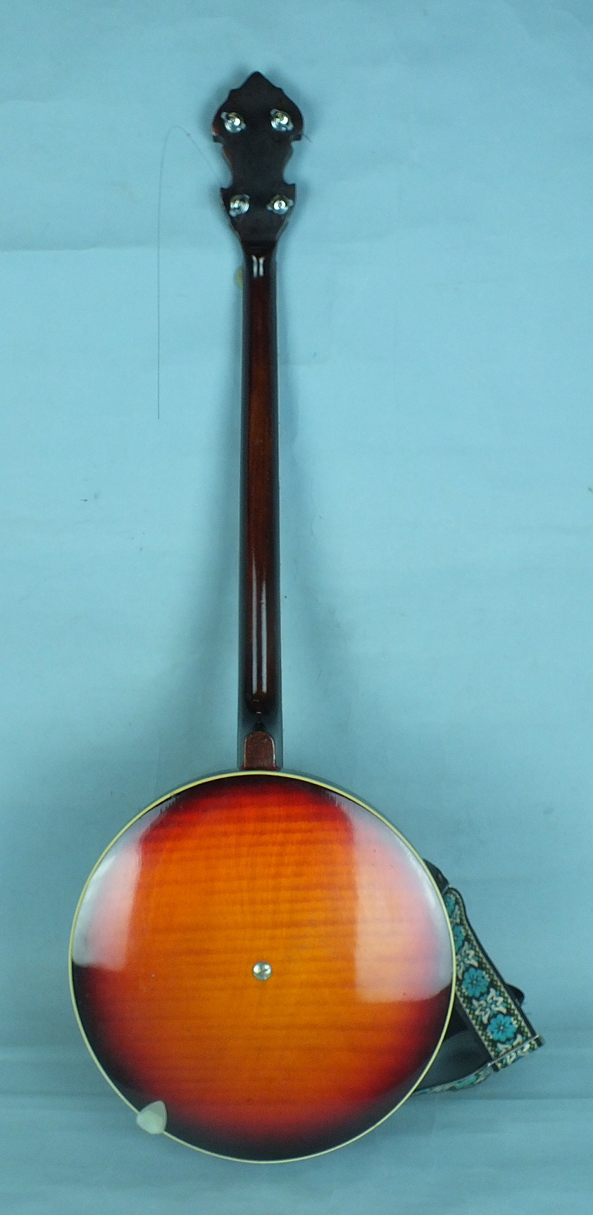 A four-string banjo with 'Remo Weather King' banjo head, 95cm overall ...