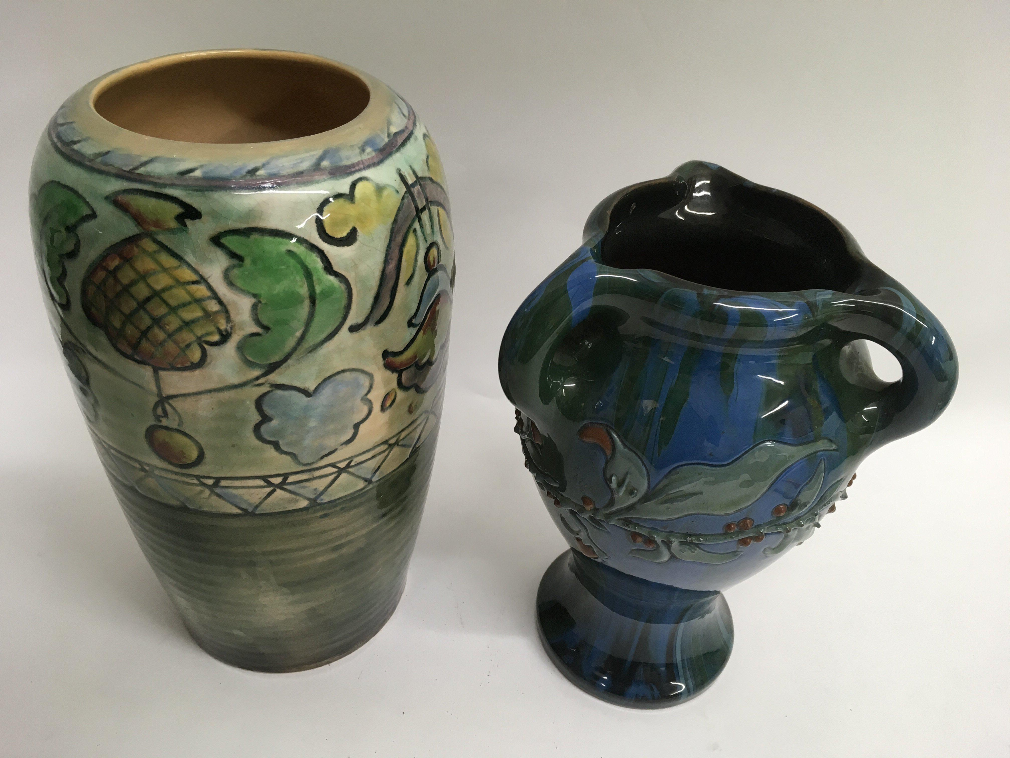 An Elton pottery tyg handled vase with applied leaf decoration and a ...