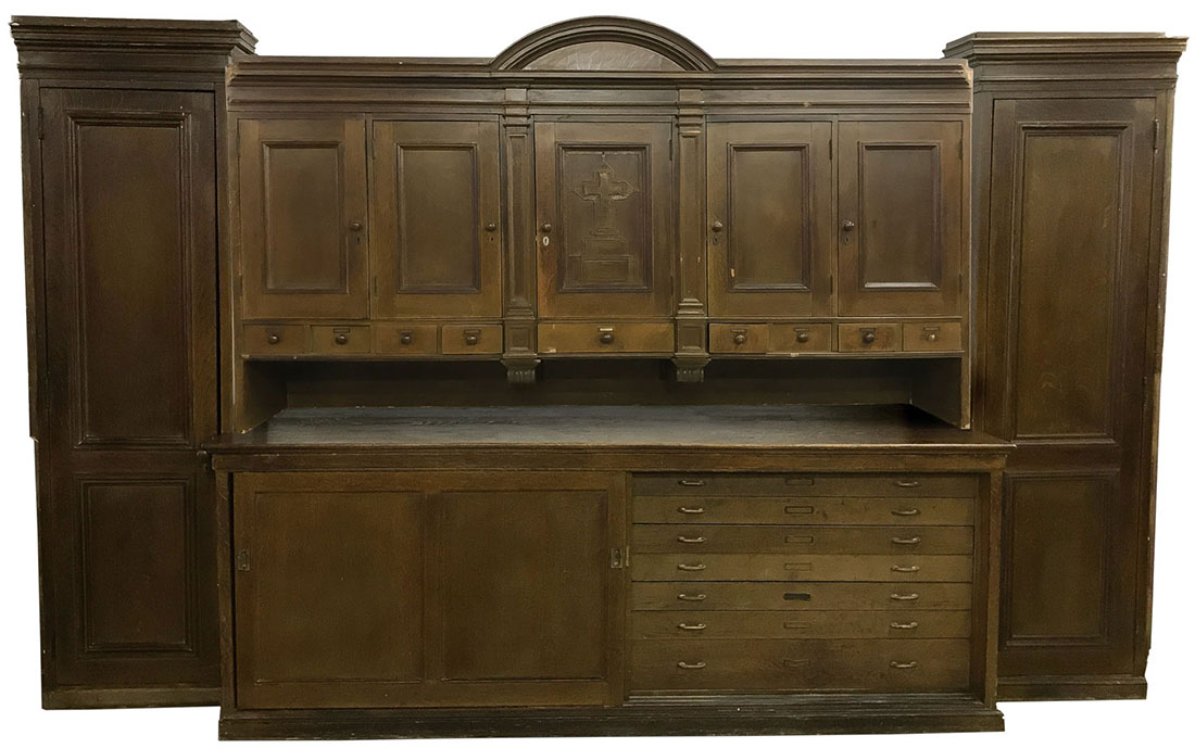 A SUBSTANTIAL SACRISTY CABINET. The base with seven large vestment ...