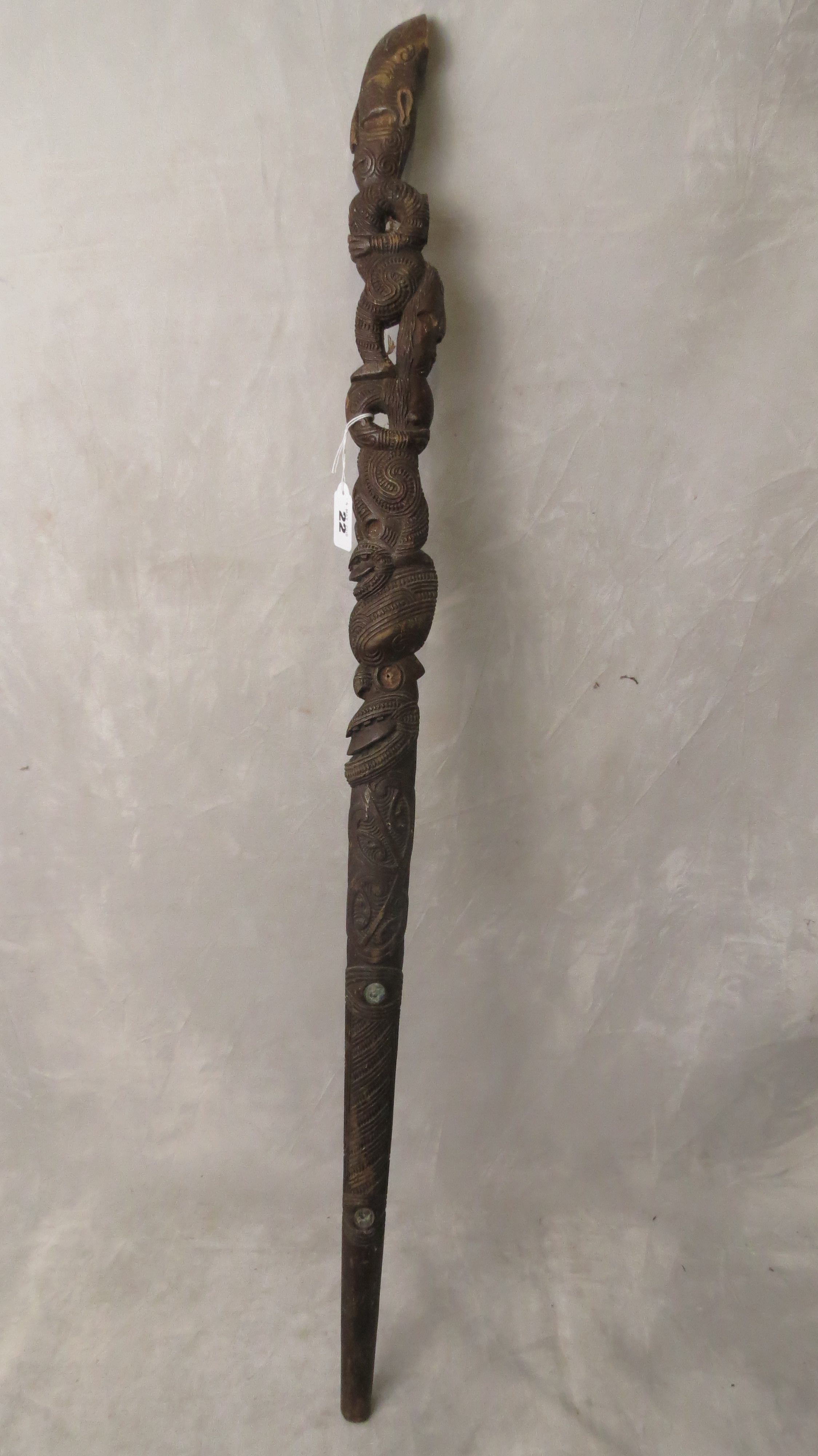 A Maori carved wooden staff set with abalone shell discs A/F