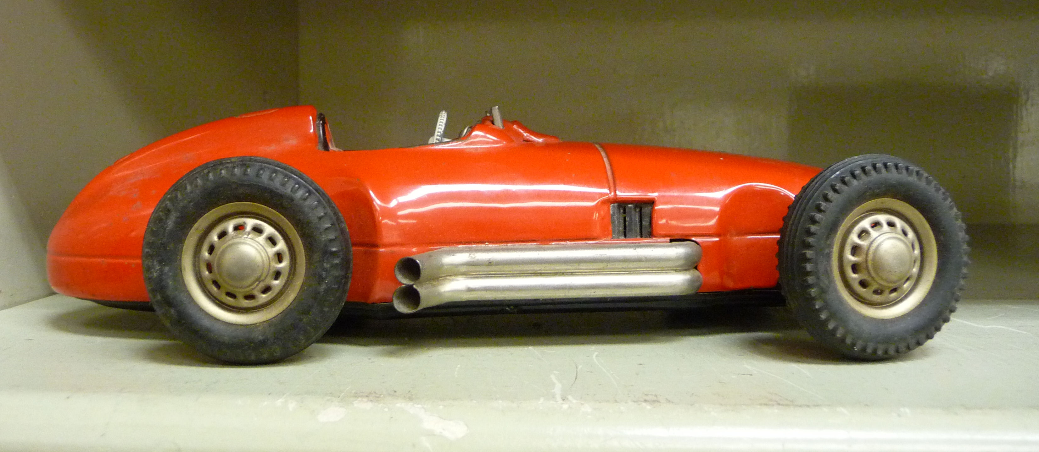 A 1950s West German made red painted tinplate model Mercedes racing car ...