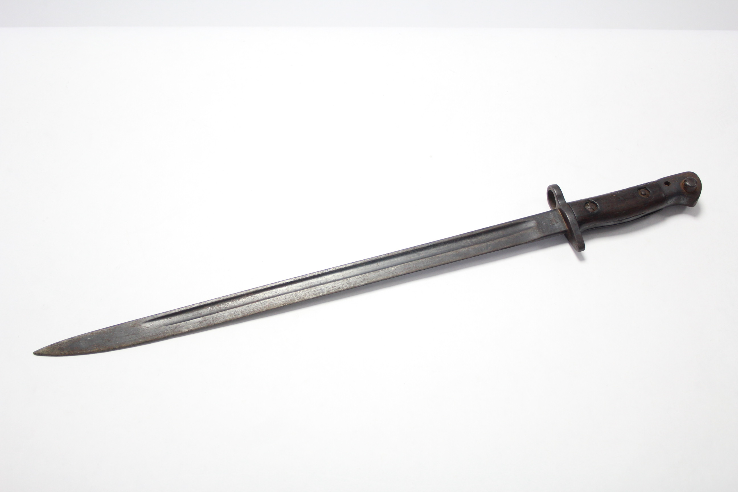 A rifle bayonet with 17” long single-edge curved blade & with hardwood ...