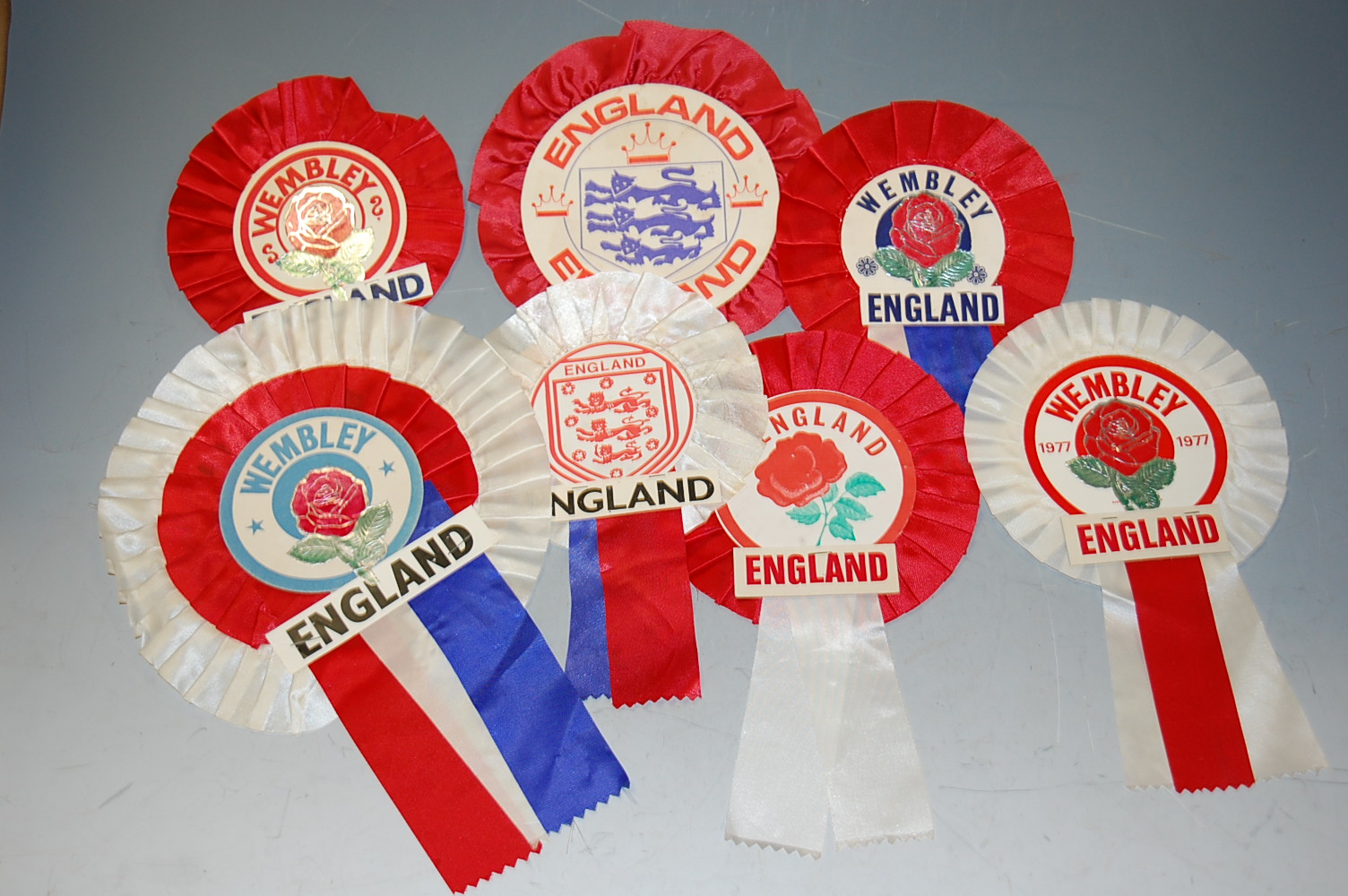 A quantity of England football rosettes; together with various England ...