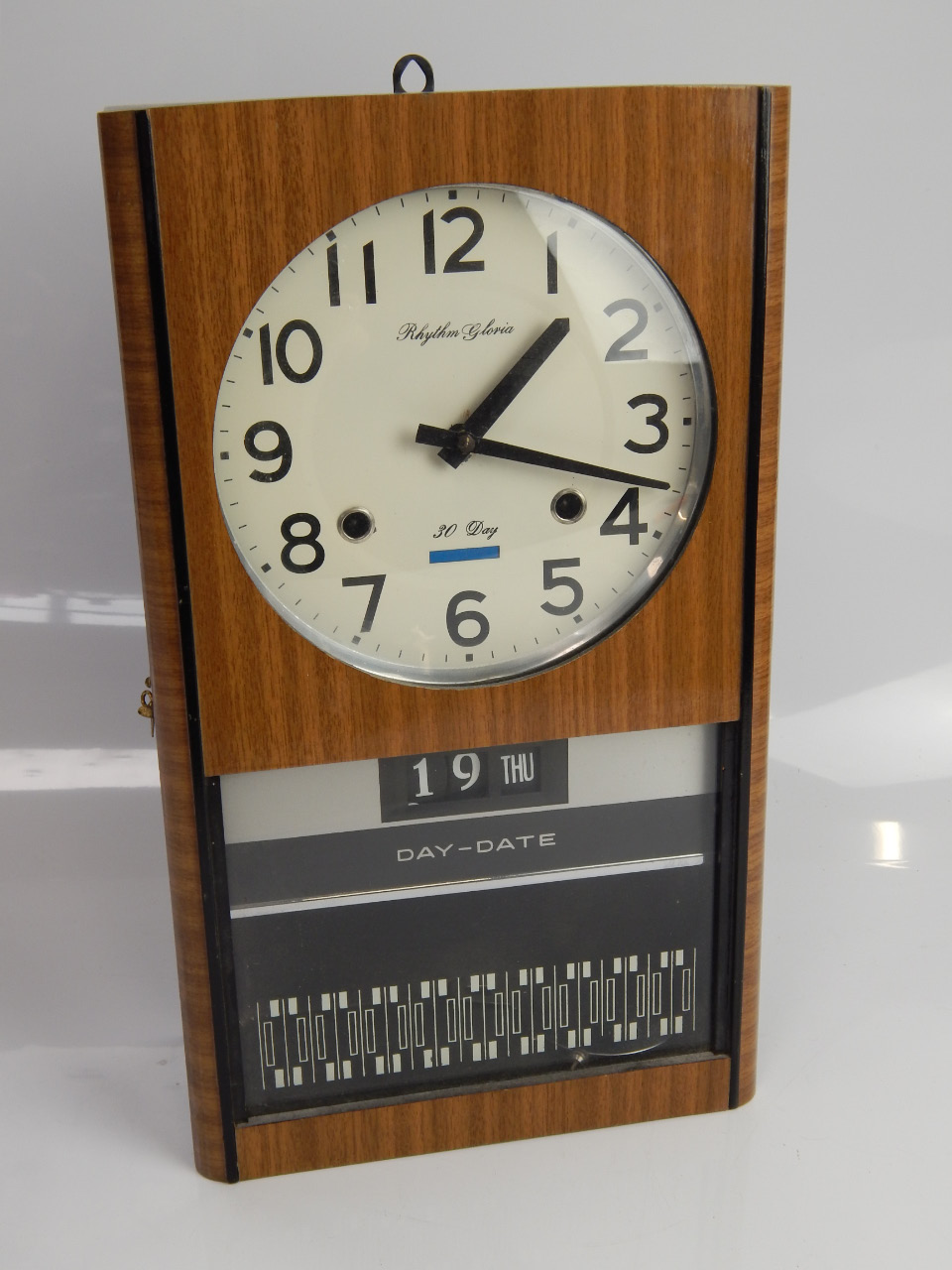 A 1960s Rhythm Gloria 30 day wall clock, with day, date apperture, in ...