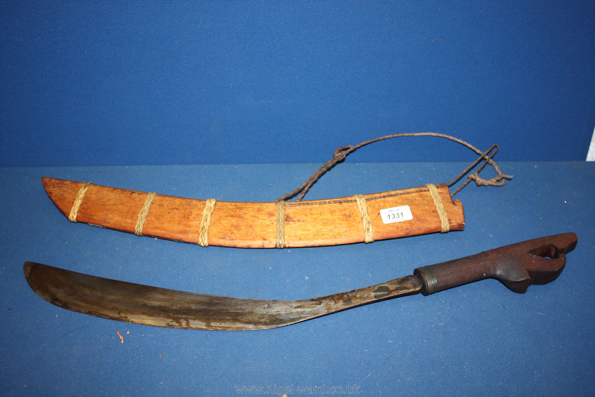 A steel curved bladed slashing Weapon having an unusual carved and ...