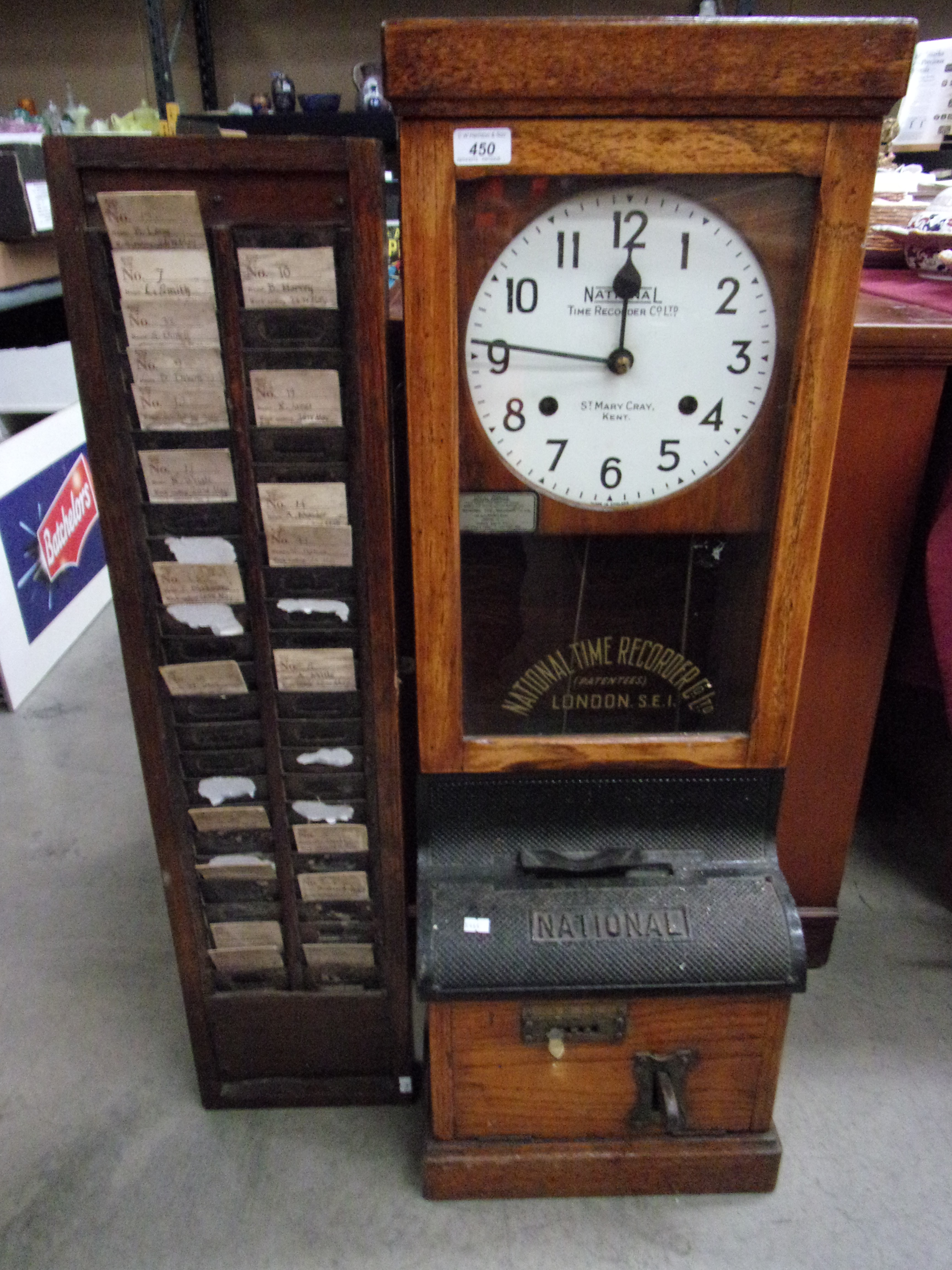 A National Time Recorder Co. Ltd. factory time clock in glazed oak case ...