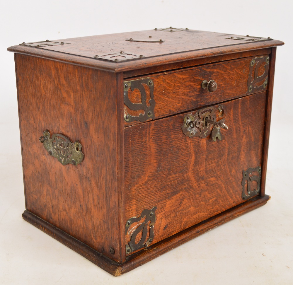 An Edwardian oak travelling box with single drawer above hinged drop ...