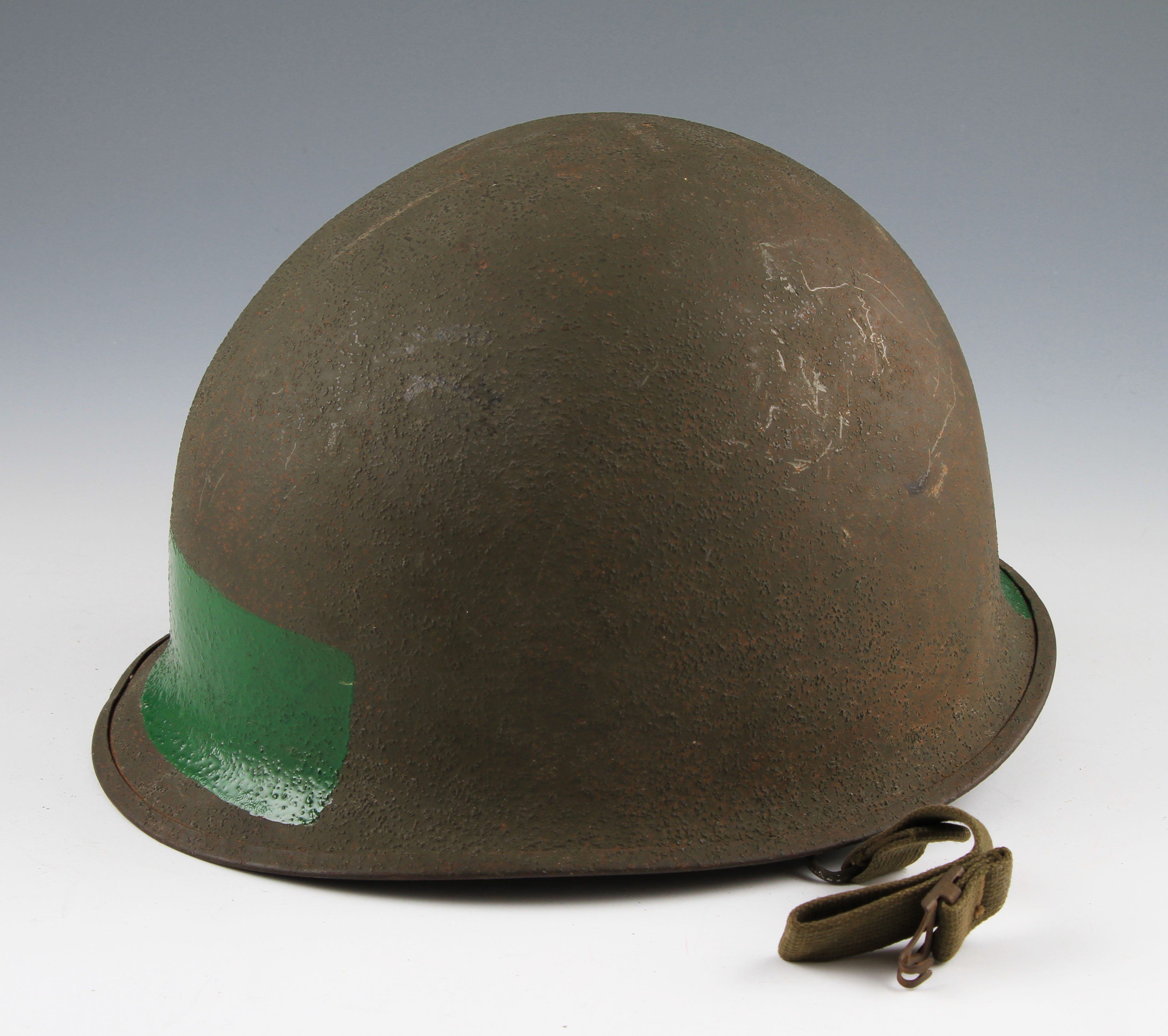 A lot to include two US M1 helmets, one having green the cover the ...