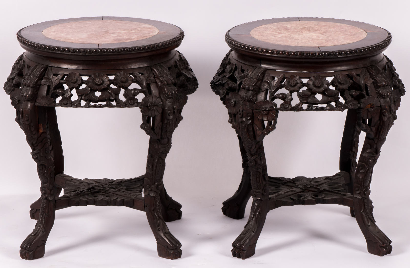 A pair of Chinese carved wooden stools with marble top, H 48 - D 47 cm