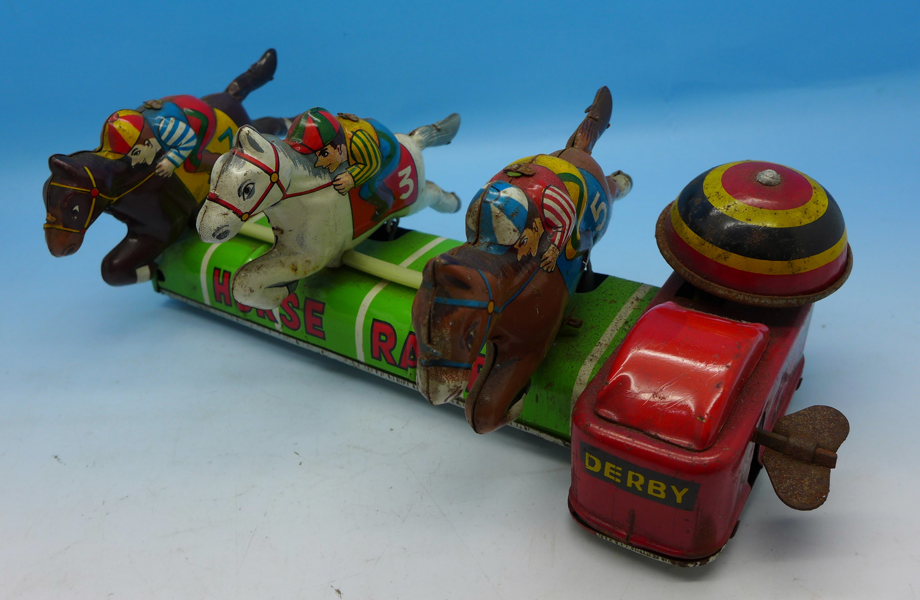 A Japanese tin-plate horse race toy