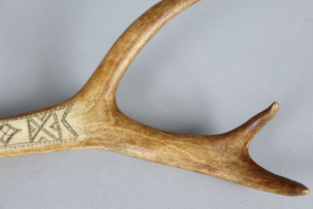 AN INUIT CARVED, REINDEER ANTLER SPOON, 19TH CENTURY, carved with ...