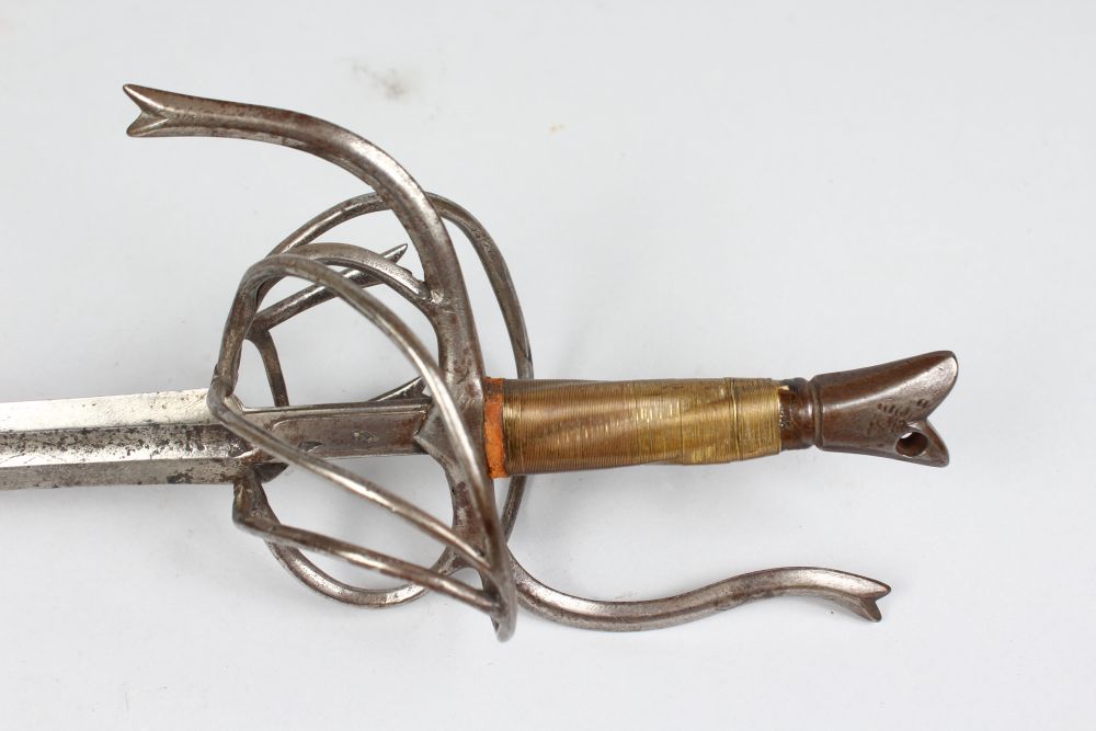 A 17TH CENTURY AND LATER BASKET HILT RAPIER, with part fullered ...