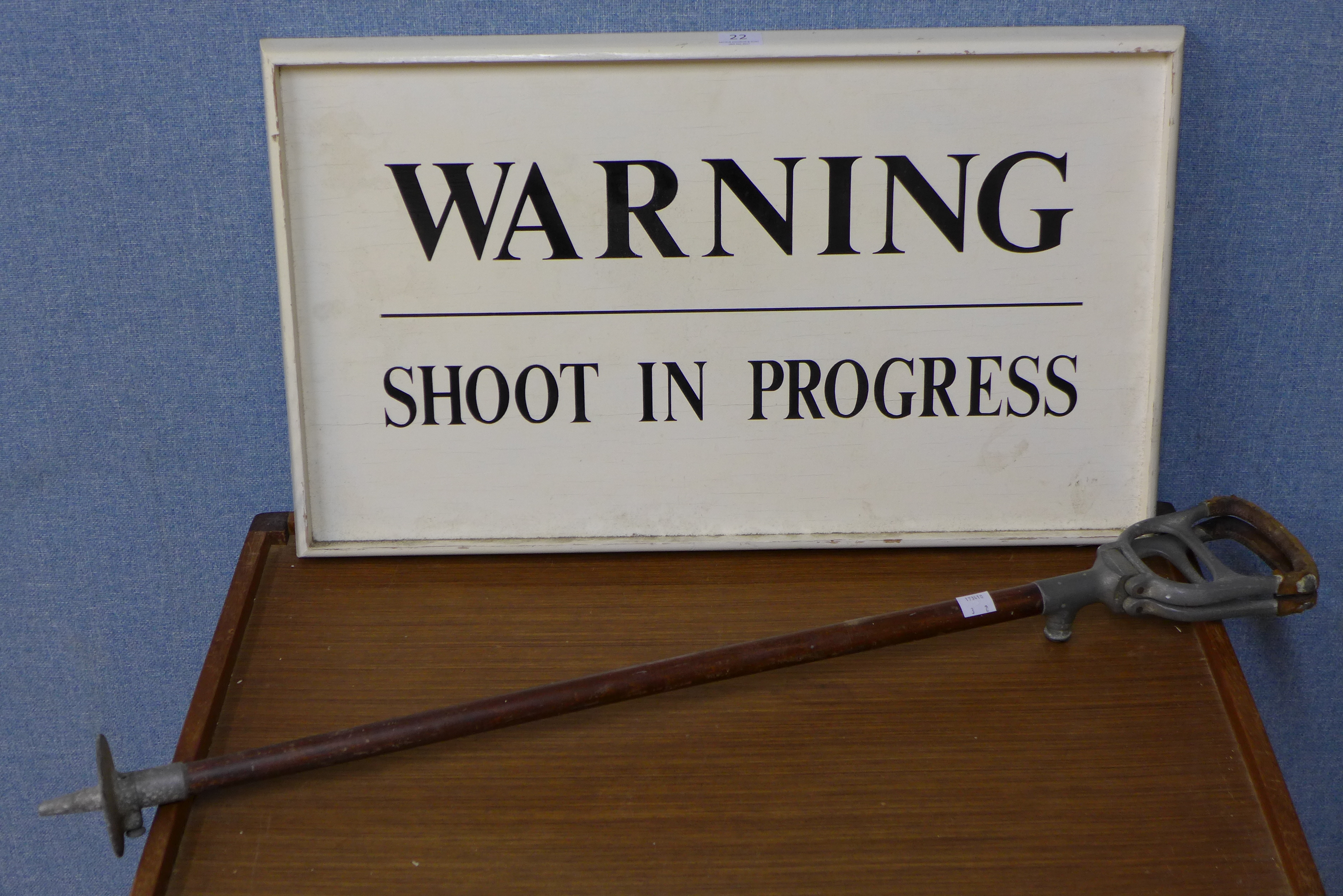 A Warning Shoot In Progress sign and shooting stick