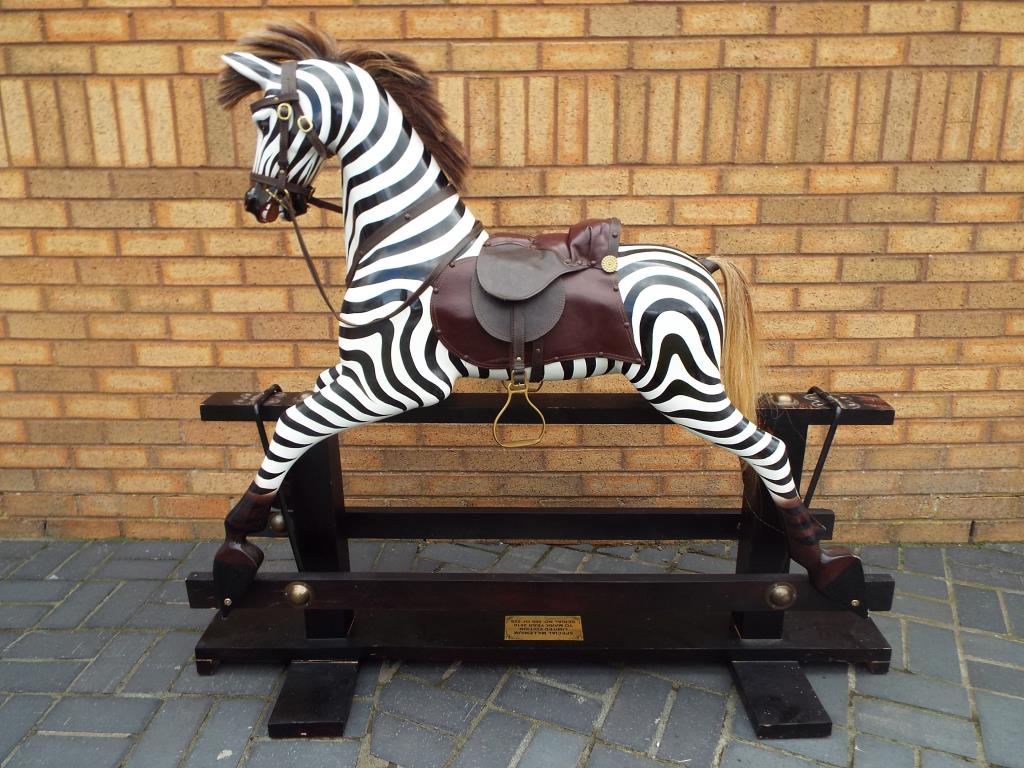 Rocking Zebra - a carved wooden rocking zebra with leather saddle and ...