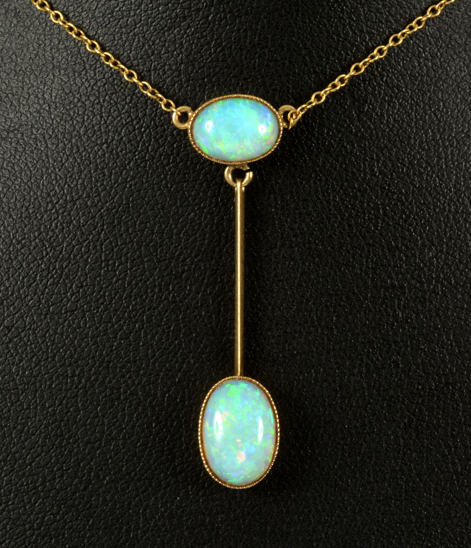 An Opal Necklace set two oval opal cabochons on fine chain and a ...
