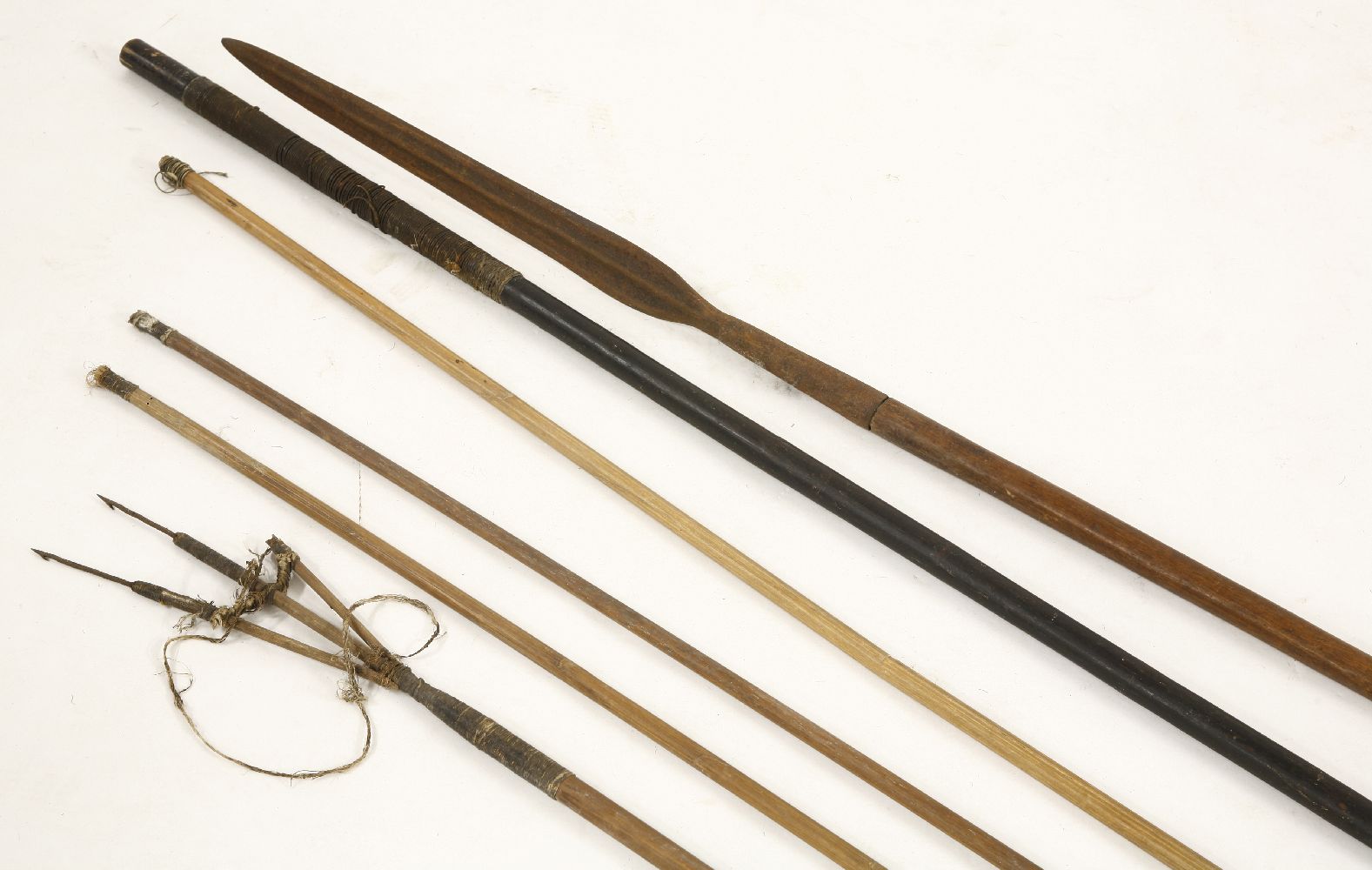 Six tribal items, a Polynesian multi prong spear, a blow pipe, and four ...