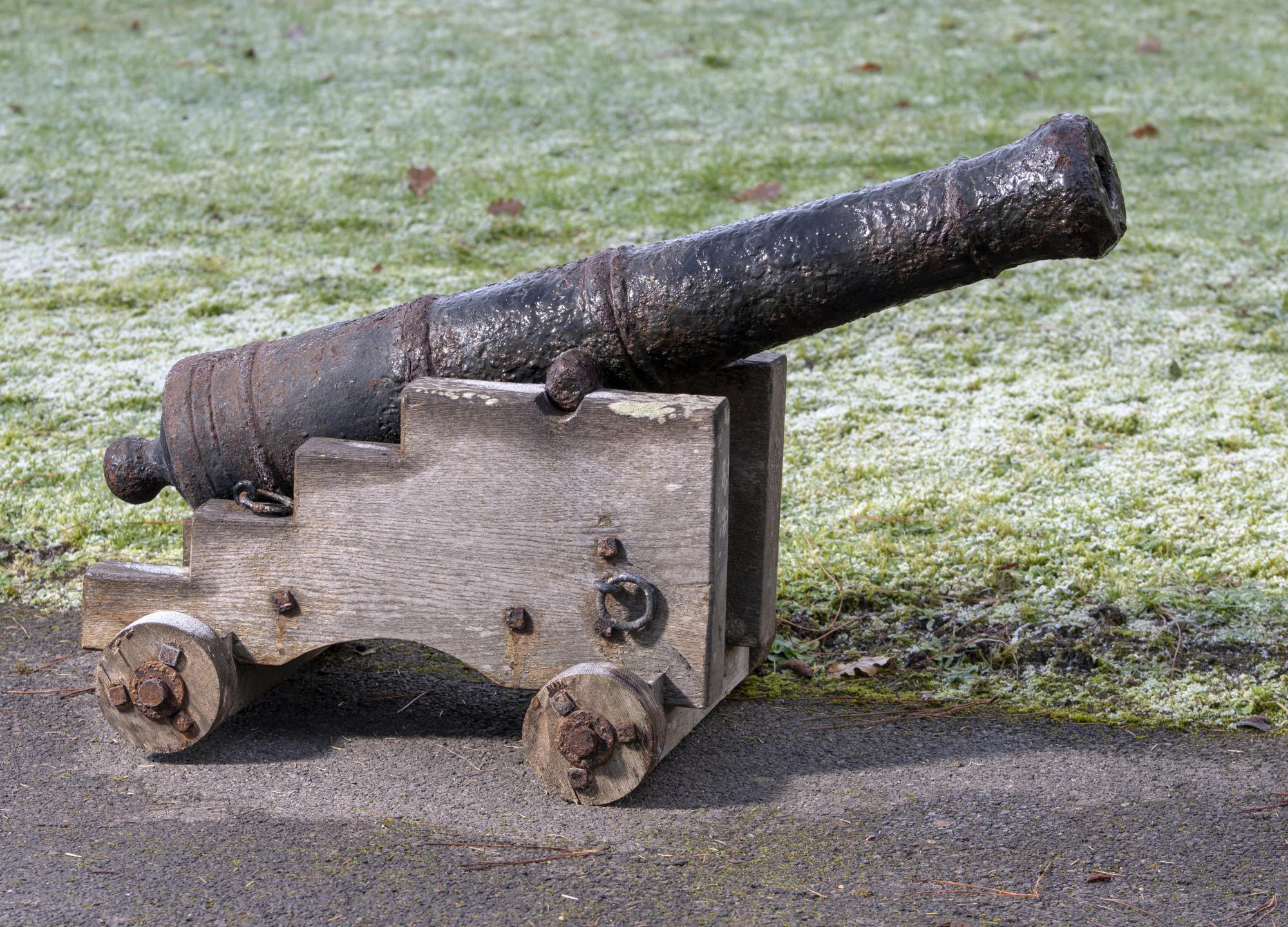 Militaria: A small cast iron cannon 19th century on later wooden ...