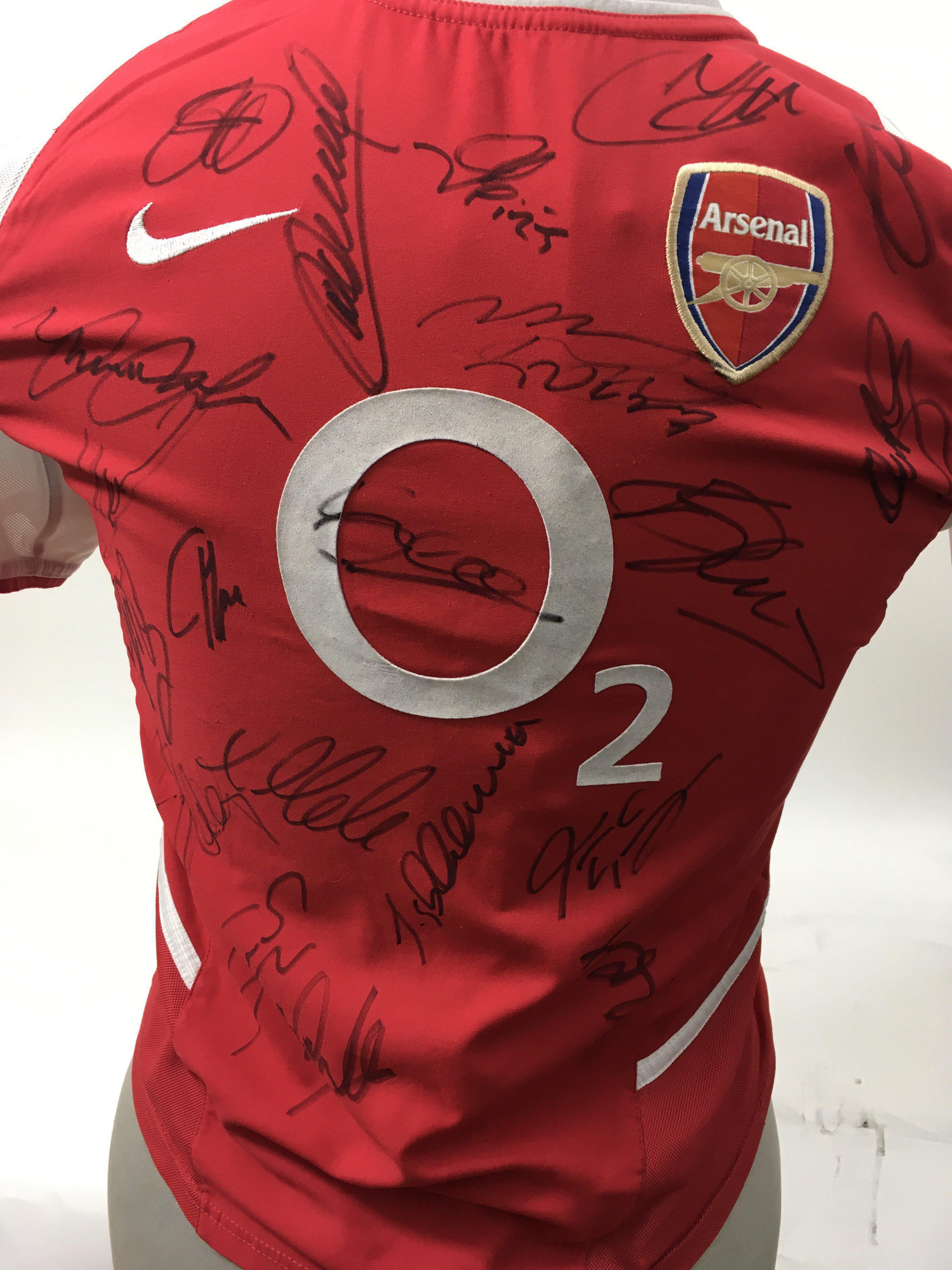 A child's Arsenal football shirt signed by the 2004 Invincibles team ...
