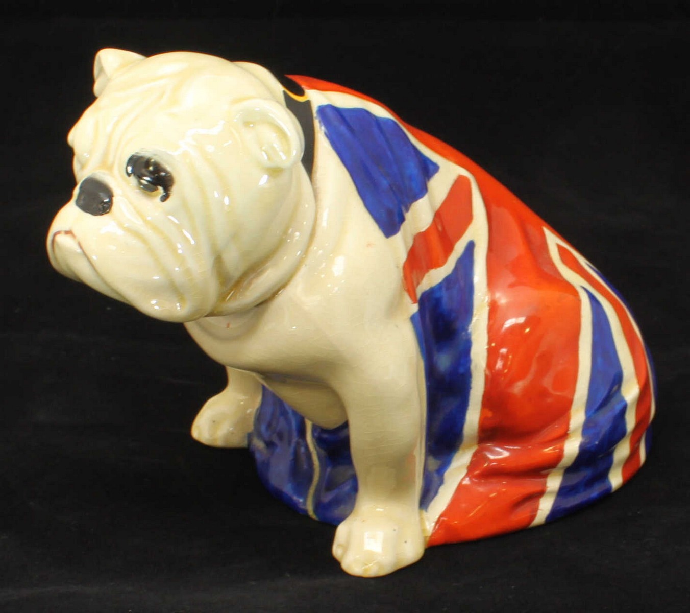 A Royal Doulton figure of a British Bulldog with Union Flag draped over ...