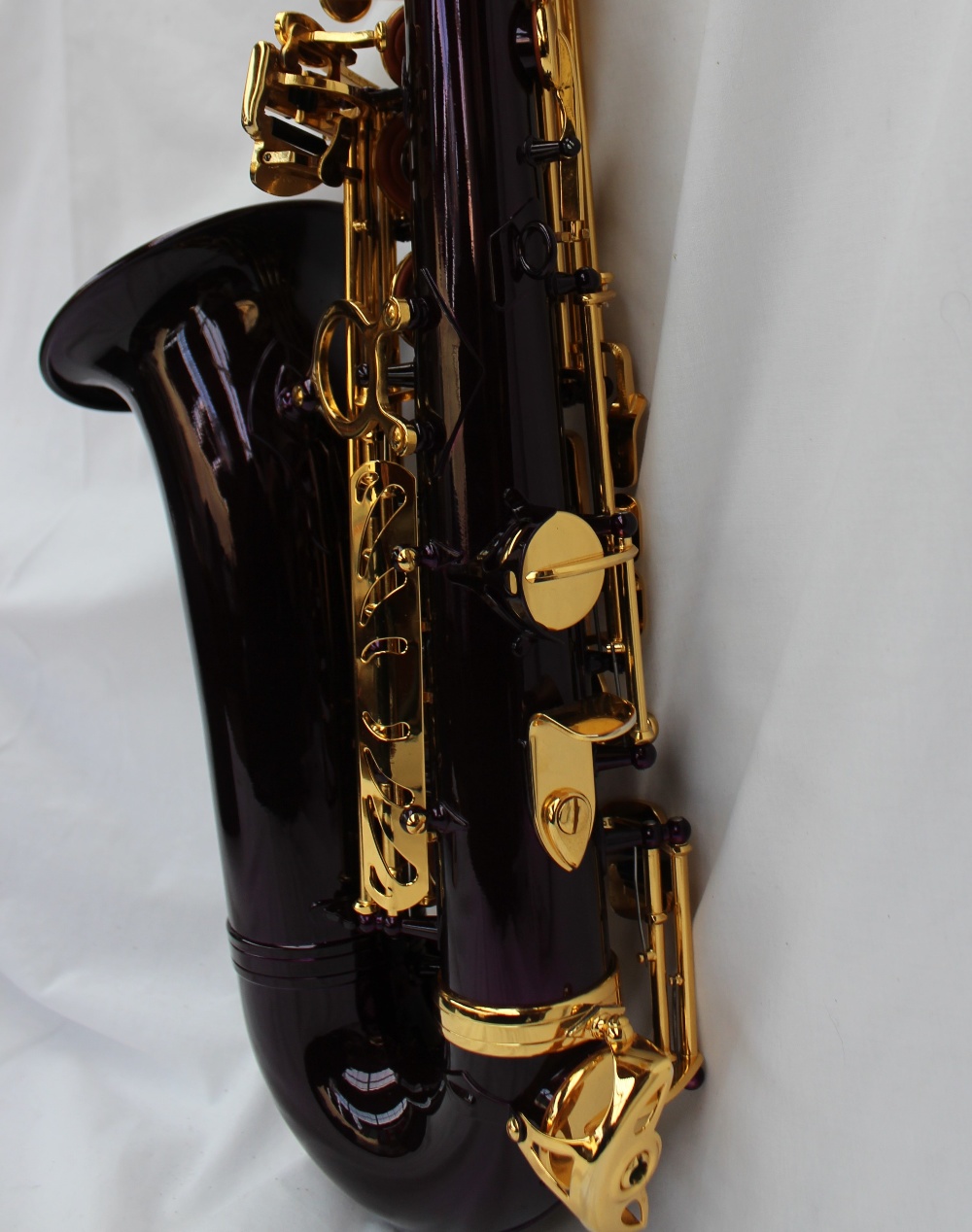 A Sunrise purple lacquer saxophone, in a lined case with stand