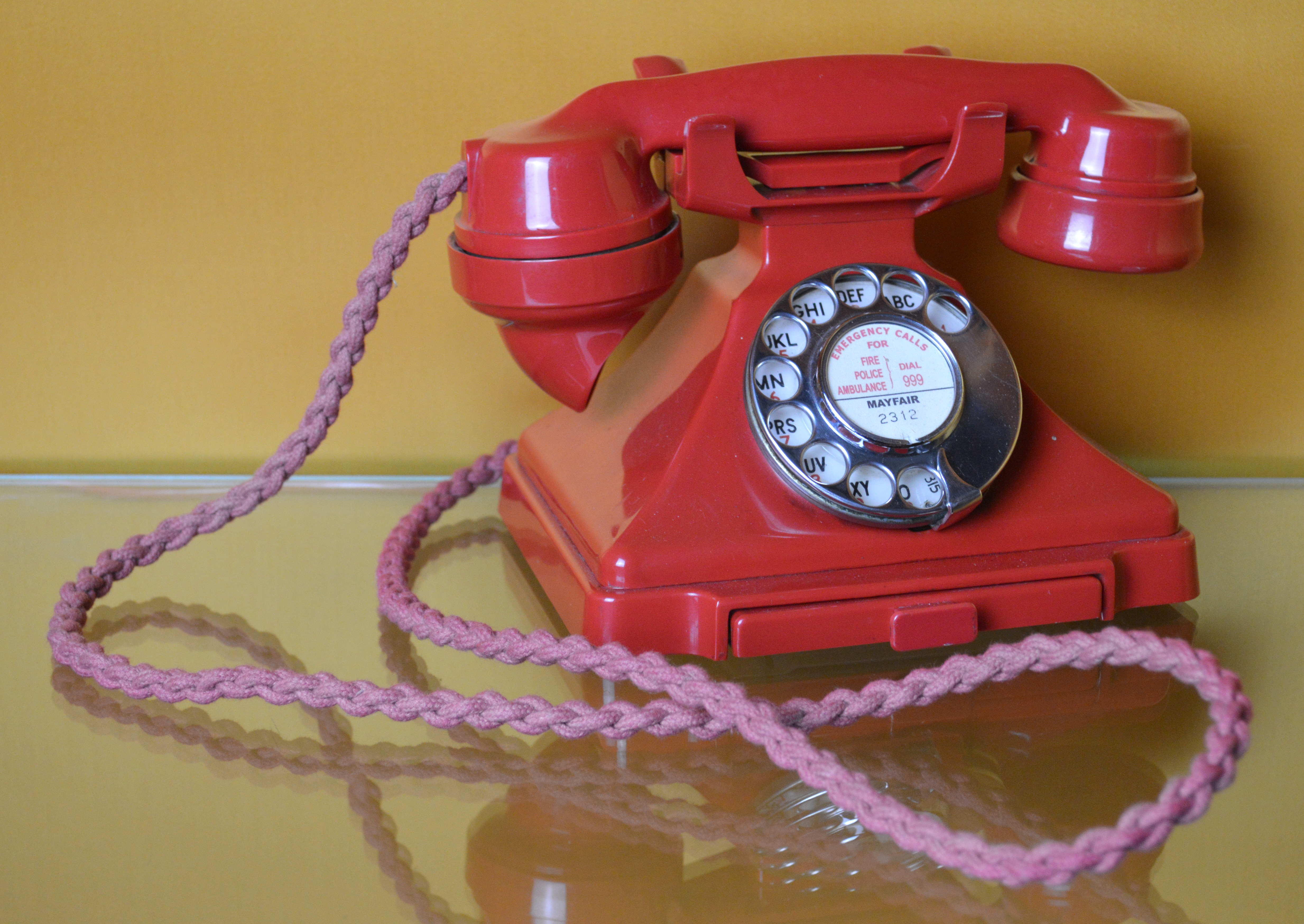 A VINTAGE RED BAKELITE TELEPHONEWith chrome dial.