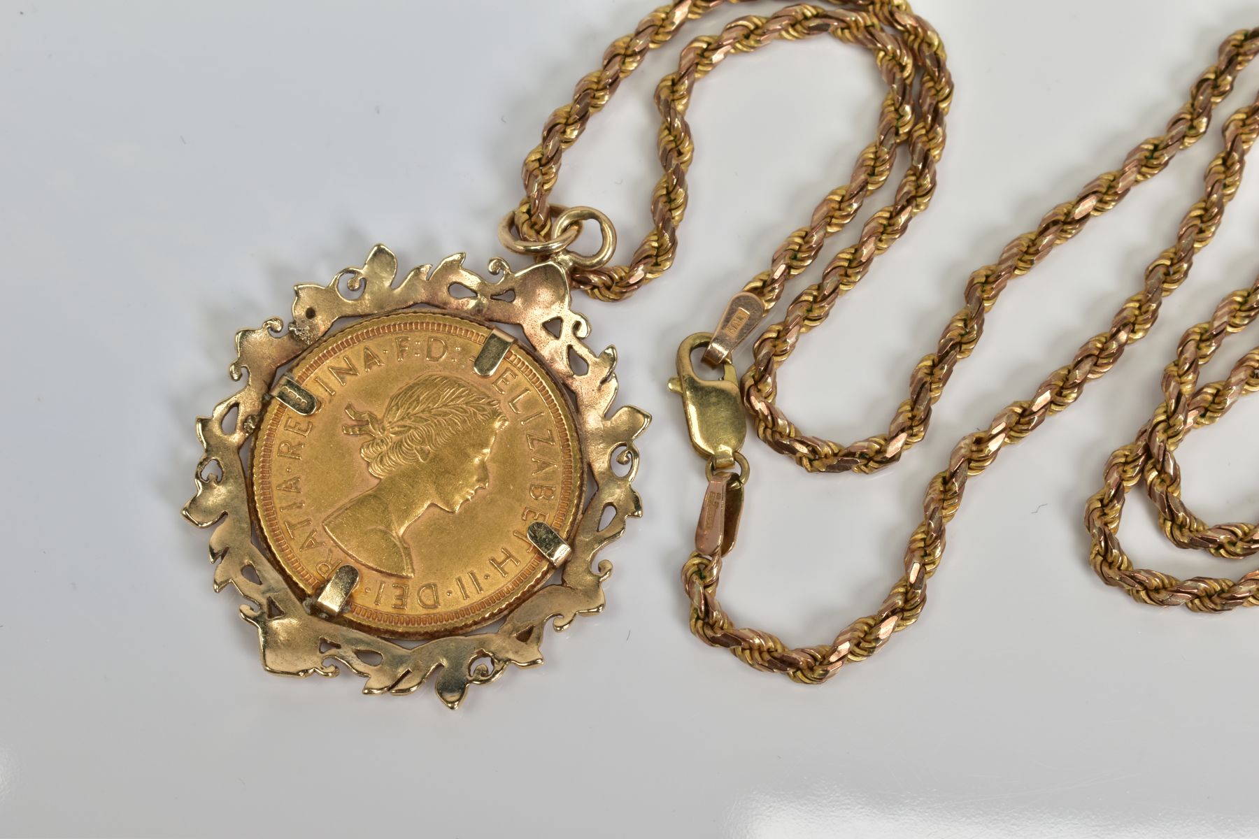 A SOVEREIGN PENDANT AND CHAIN, the full 1958 sovereign within a 9ct ...