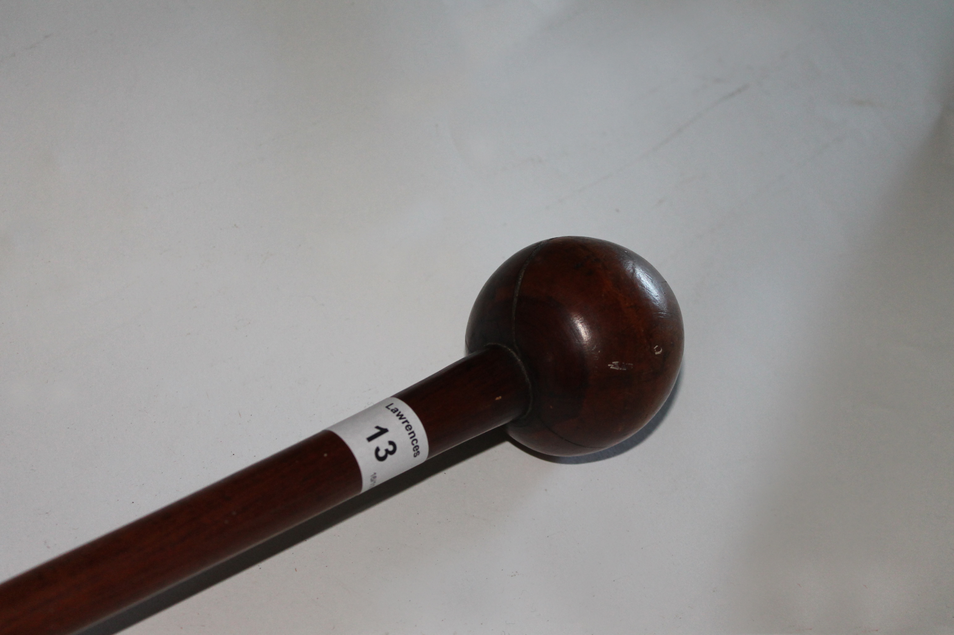 A KNOBKERRIE. A South African Knobkerrie with 24.3/4" handle and bi ...