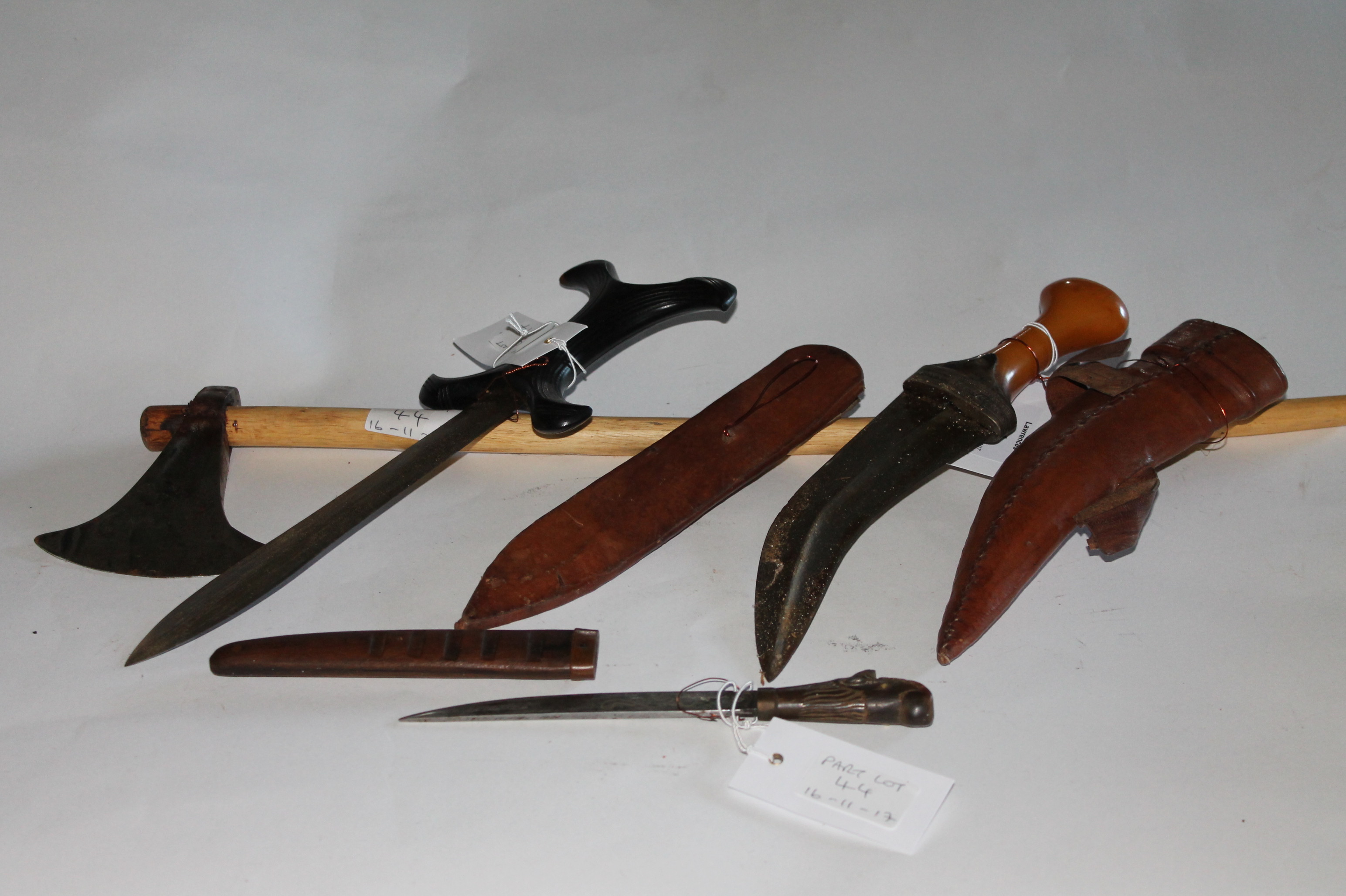 AN AXE & NATIVE KNIVES. An axe on a thin shaft from the Yemen region of ...