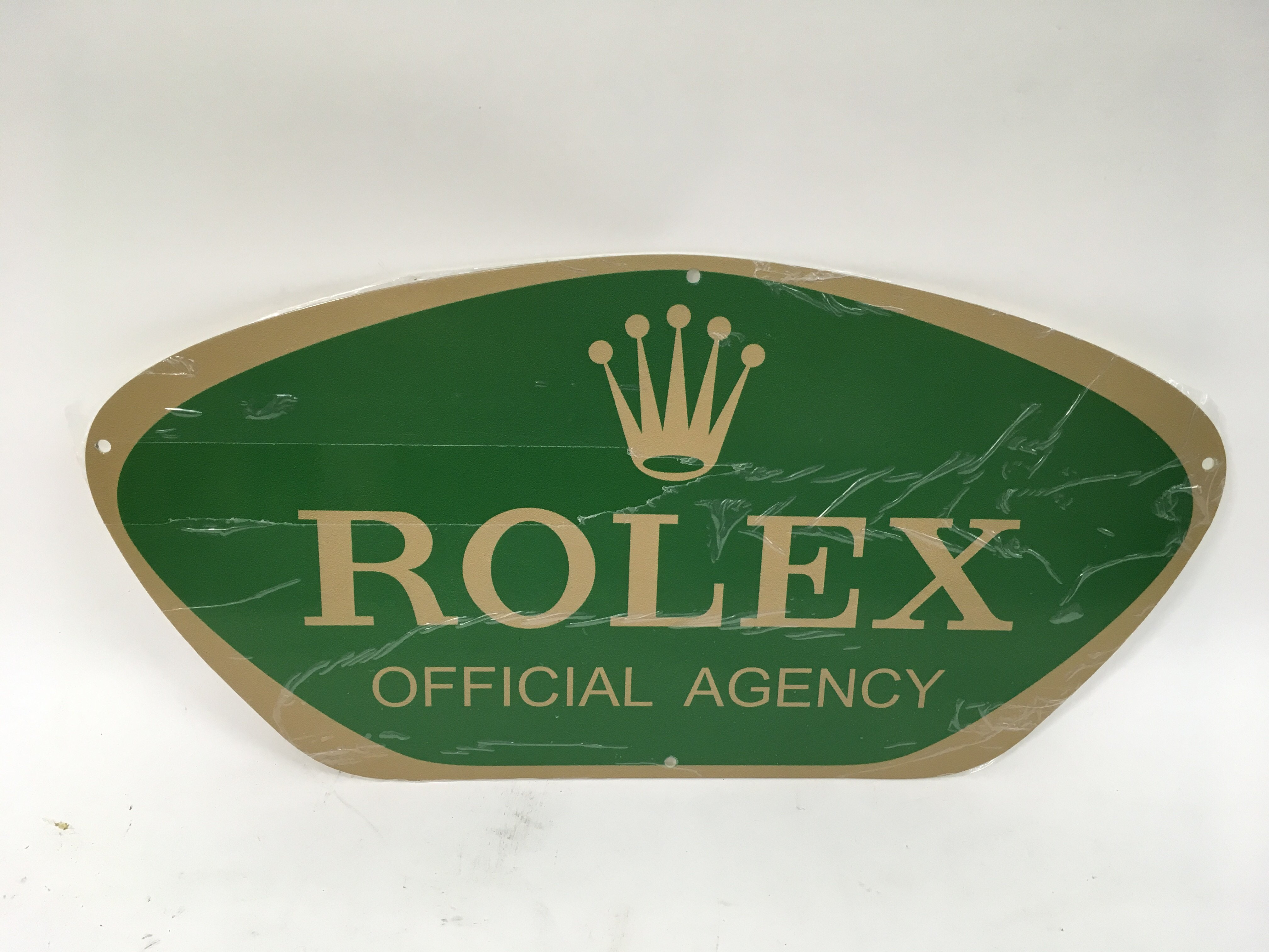 A metal Rolex advertising sign. Approximately 18 x 9 inches.