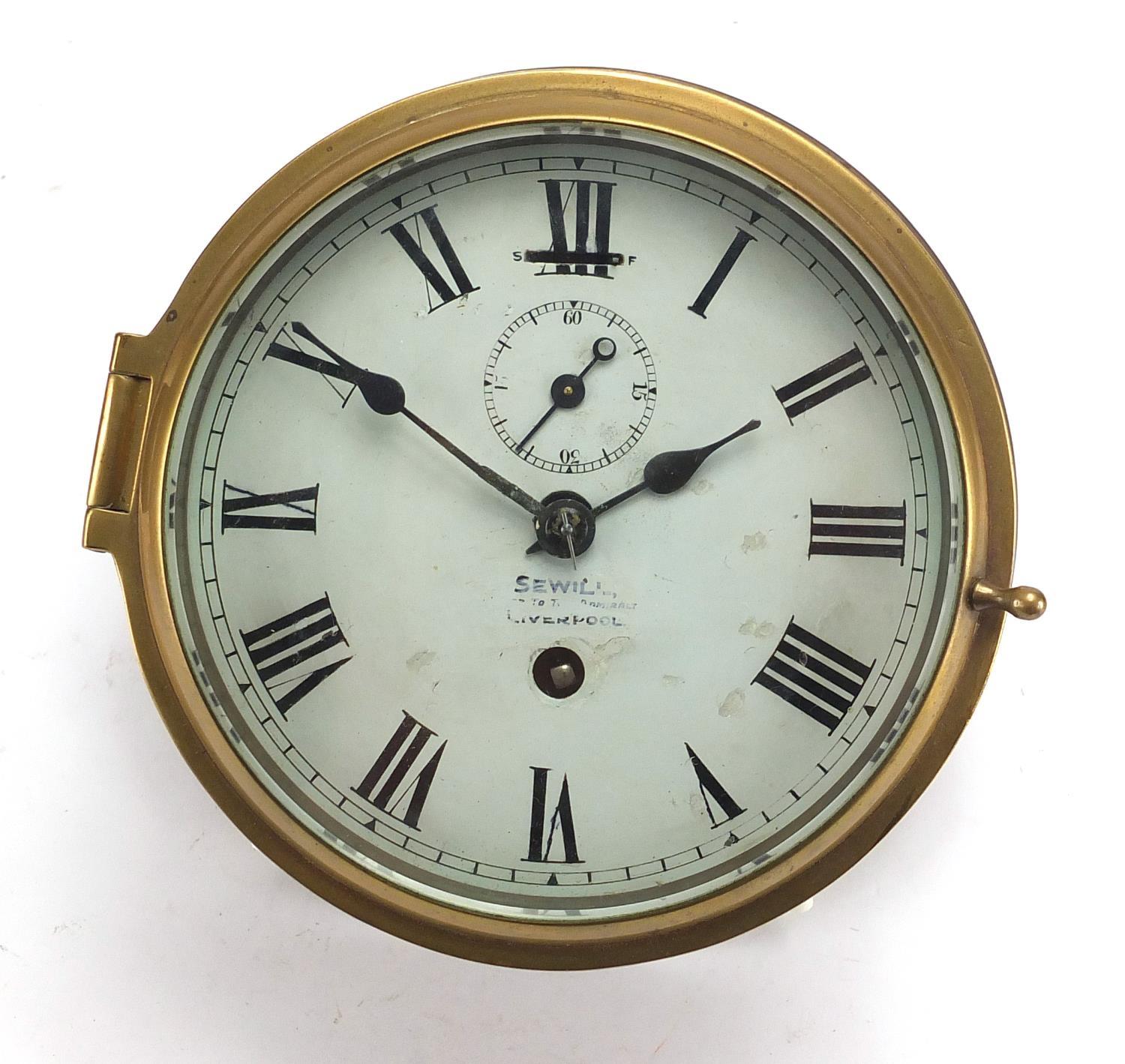 Brass ships bulkhead clock with circular painted dial inscribed Sewills ...