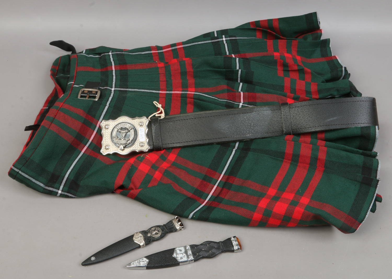 A Scottish tartan kilt, Gordon Highlanders chrome and leather belt and ...