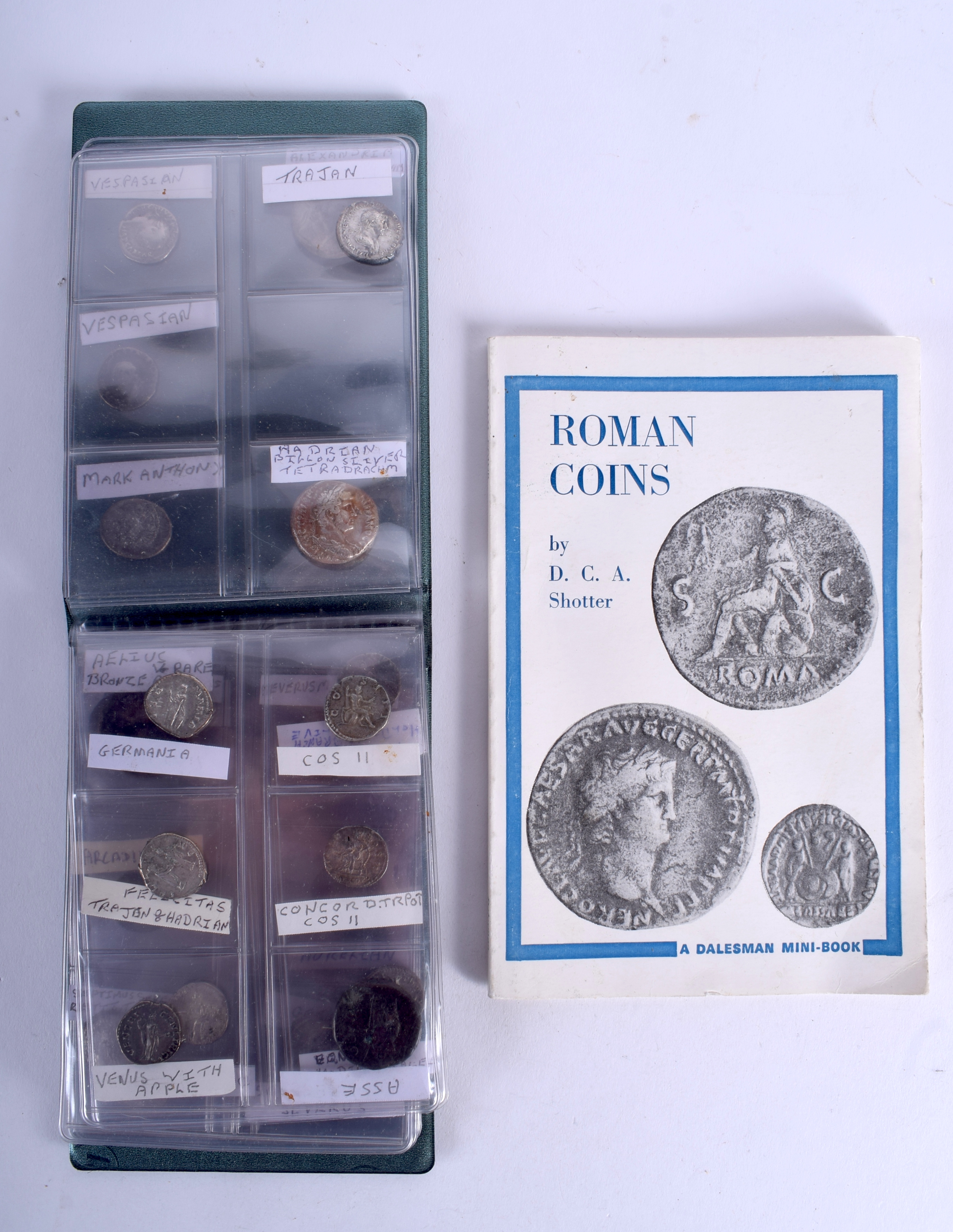 A COLLECTION OF ROMAN COINS together with a Roman coin identification ...