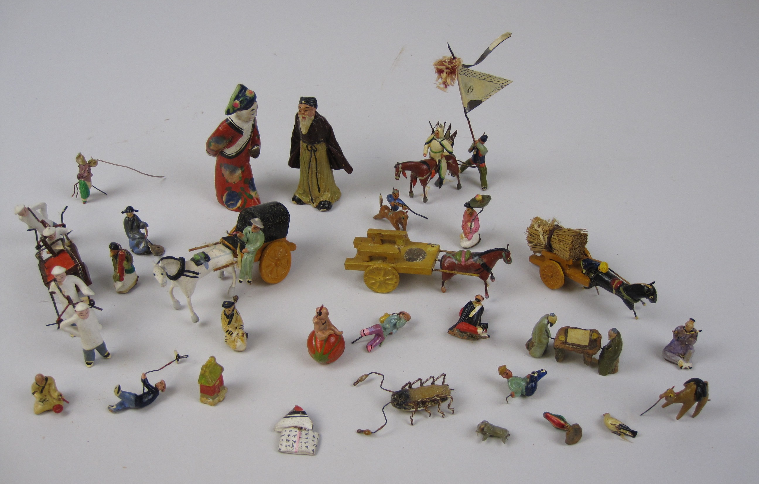 A collection of miniature Chinese Figures, clay Animals, etc