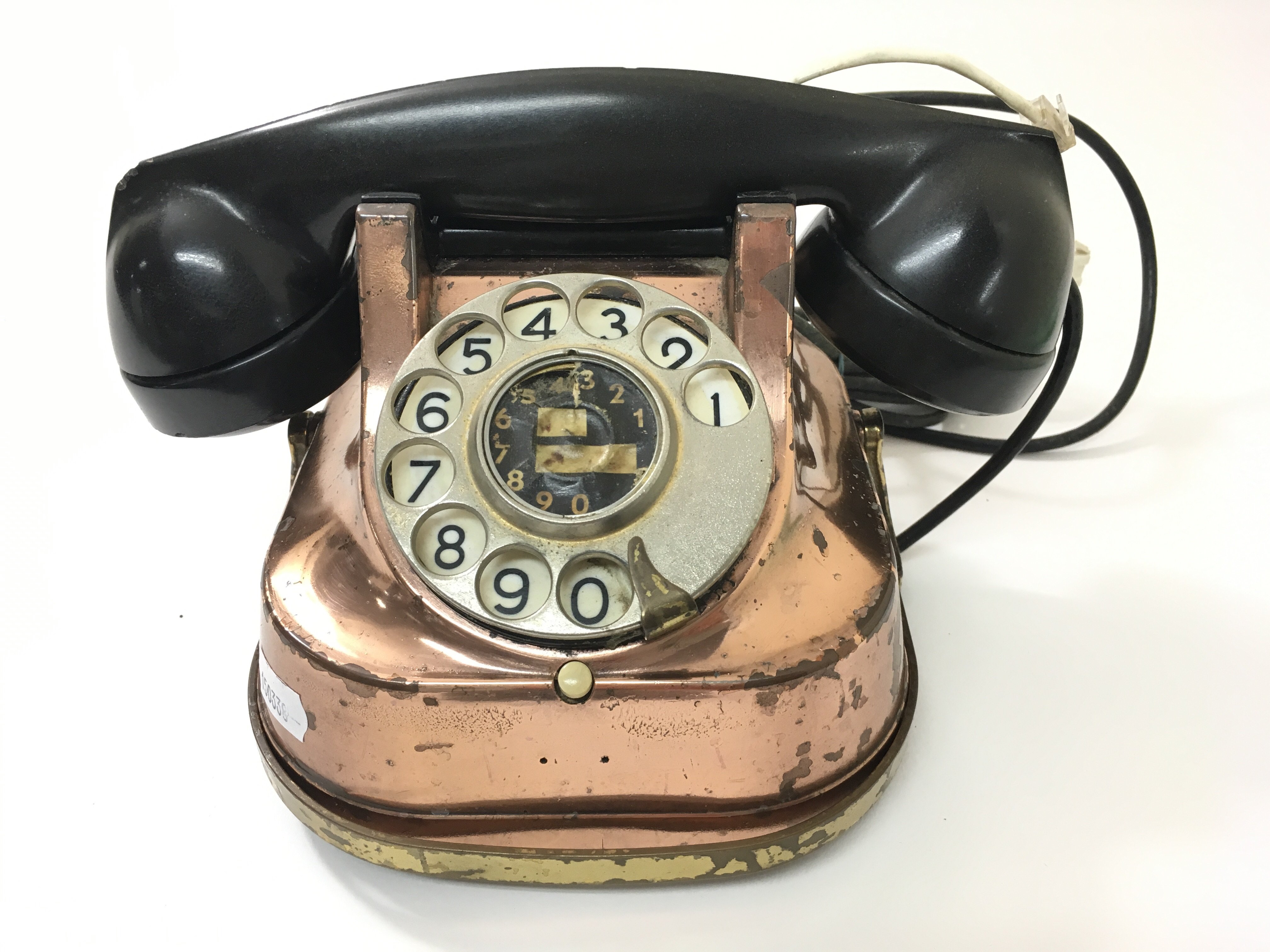 A copper and brass mounted 20th Century telephone with a Bakelite handle.