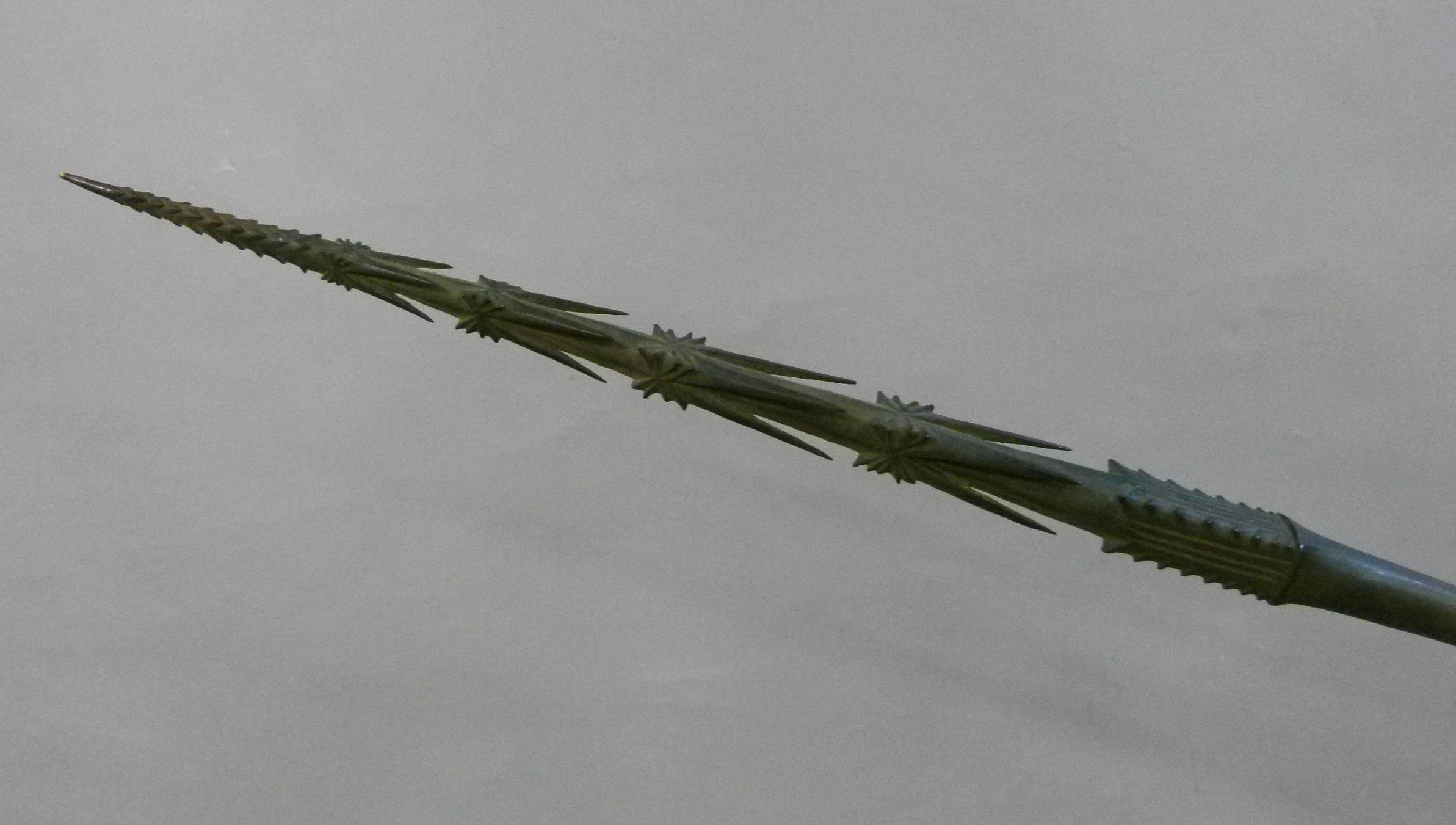 A FIJIAN FISHING SPEAR, 19th century, having a carved barbed head above ...