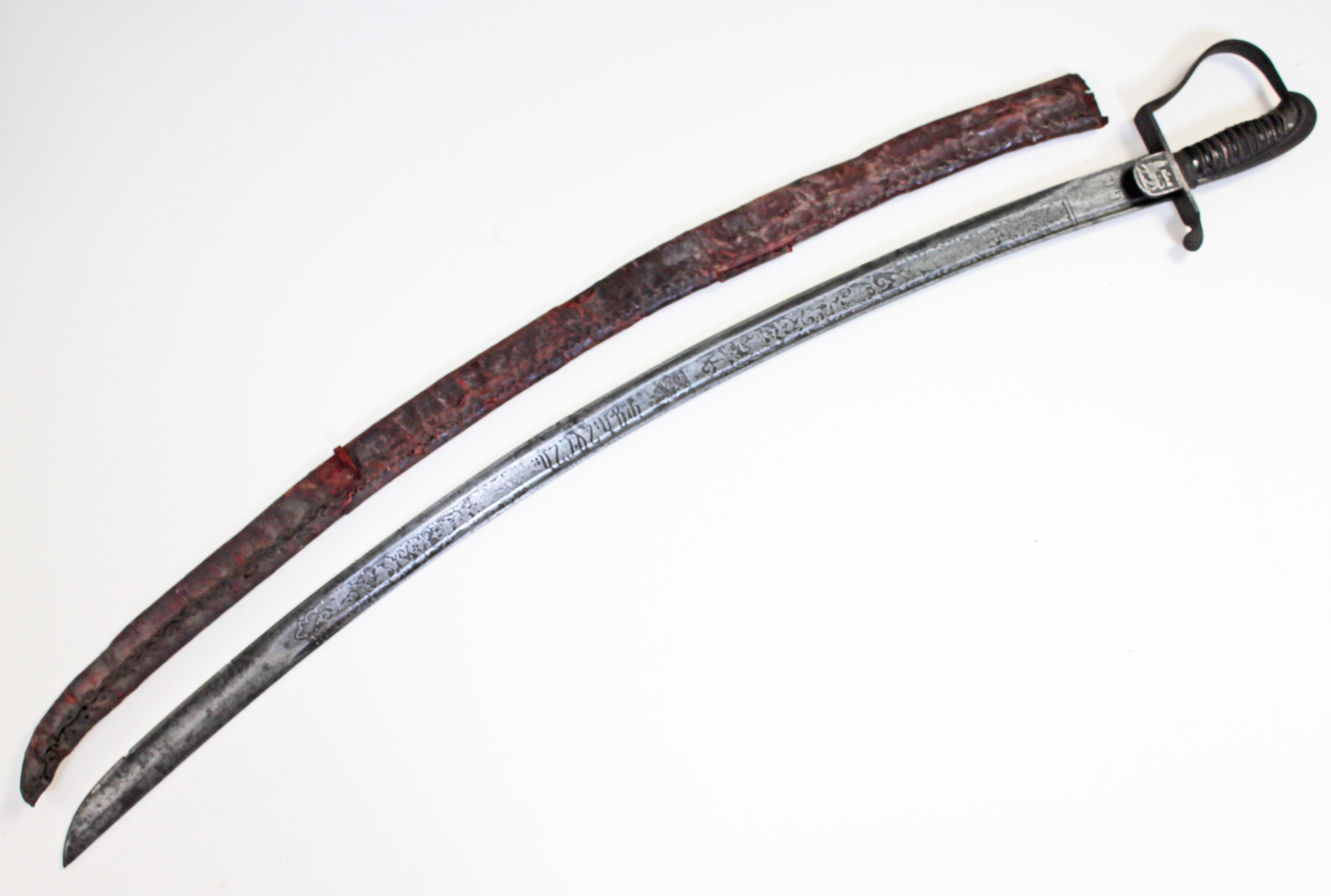 An Ethiopian cavalry sword with leather scabbard, length 94cm.