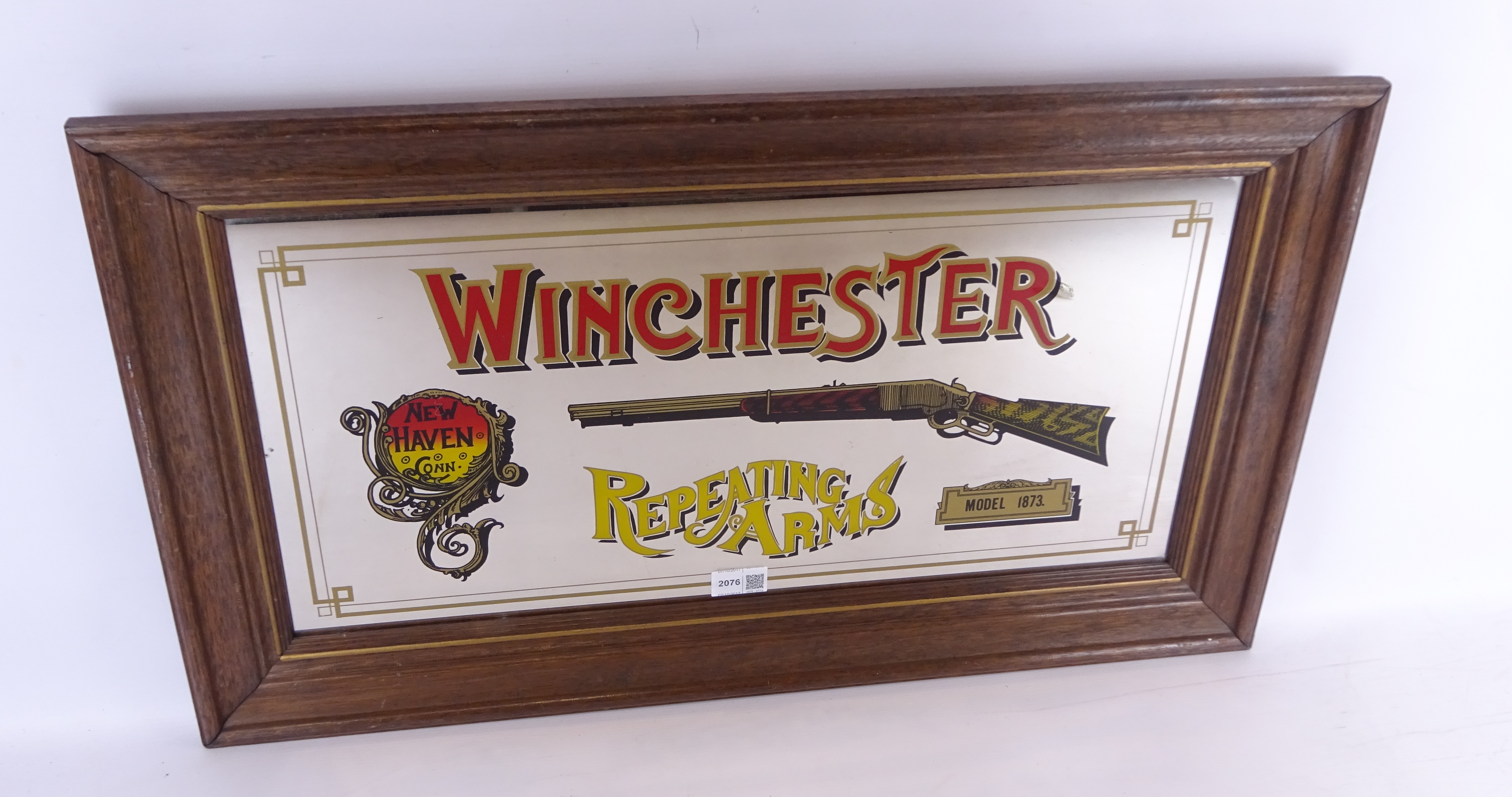 Winchester 'Repeating Arms' advertising mirror, in oak frame, 29 x 60cm ...