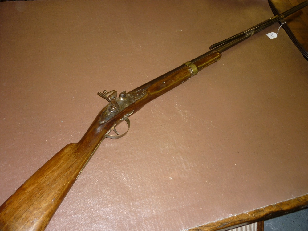 Antique flintlock rifle with a wooden stock