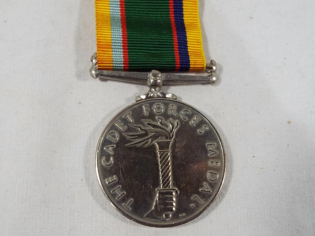 The Cadet Forces Medal with bars and ribbons inscribed to the rim Lieut ...