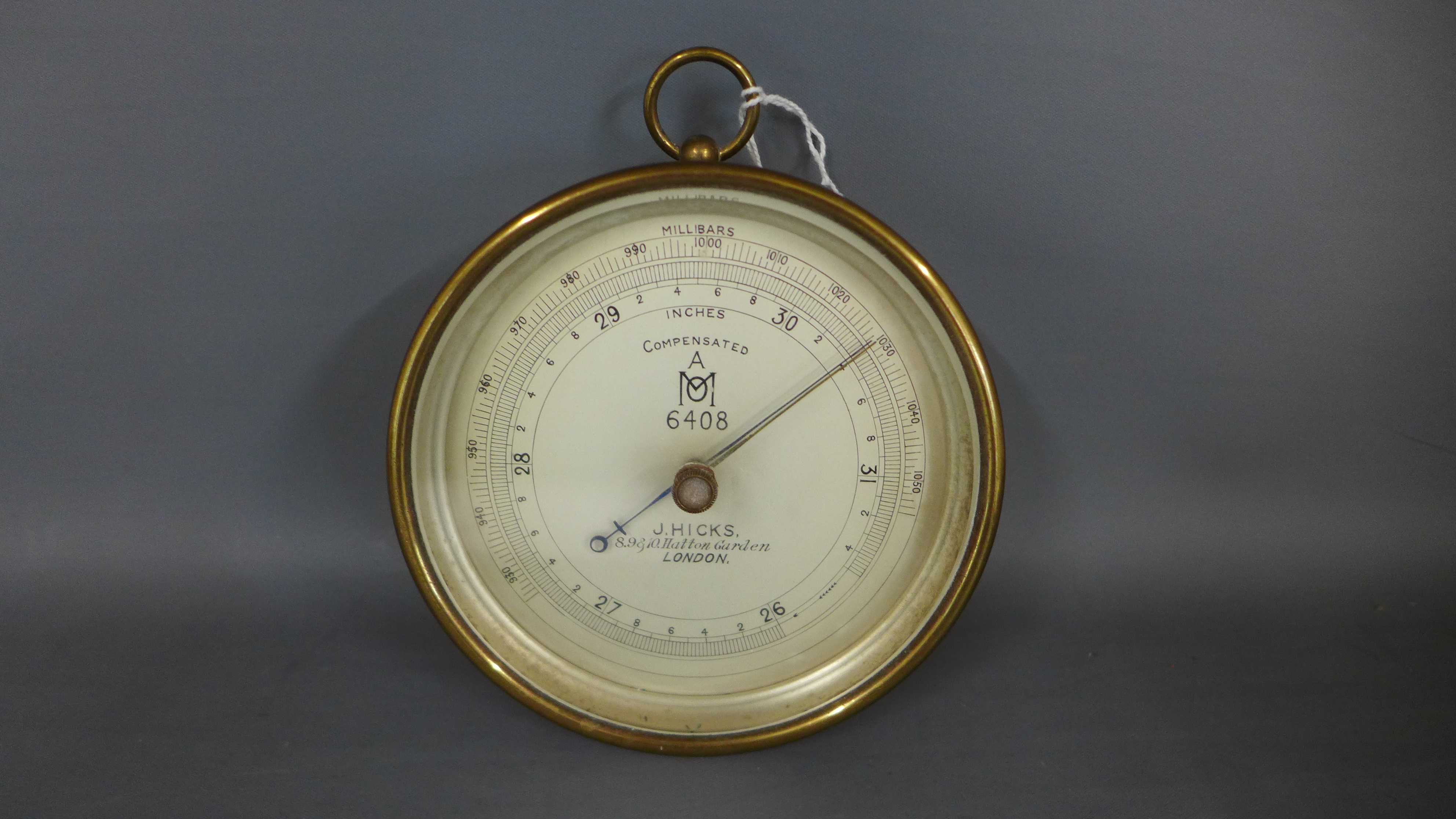 A brass Air Ministry Compensated aneroid barometer by J Hicks, Hatton ...