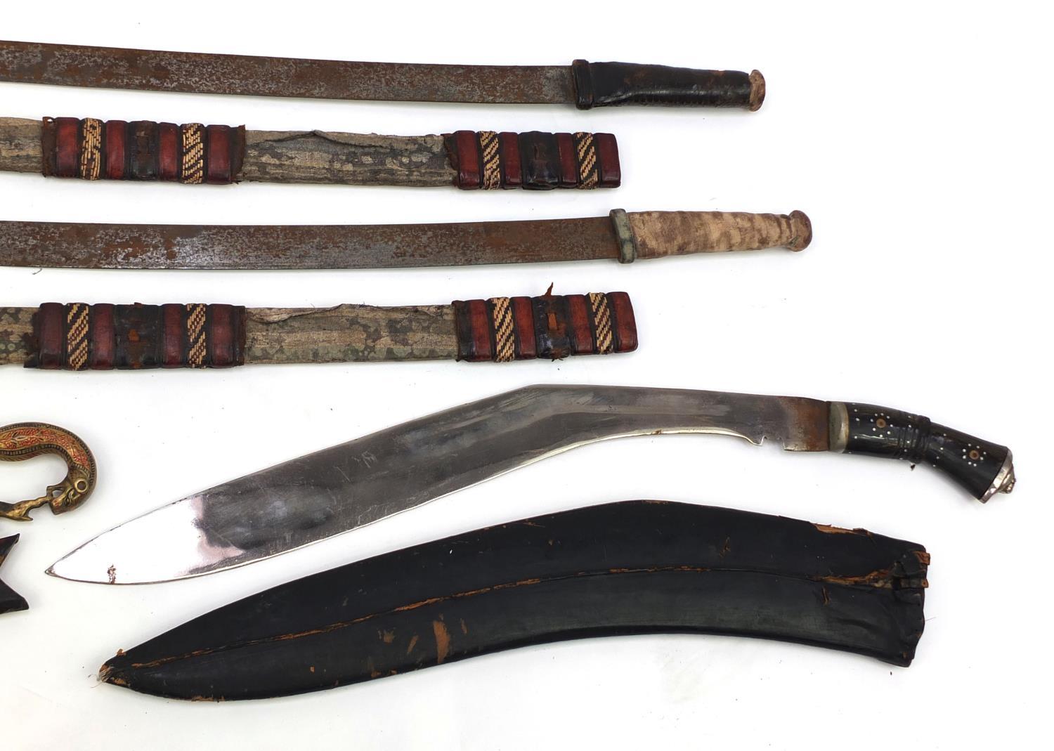Four Middle Eastern swords including two African with part leather ...