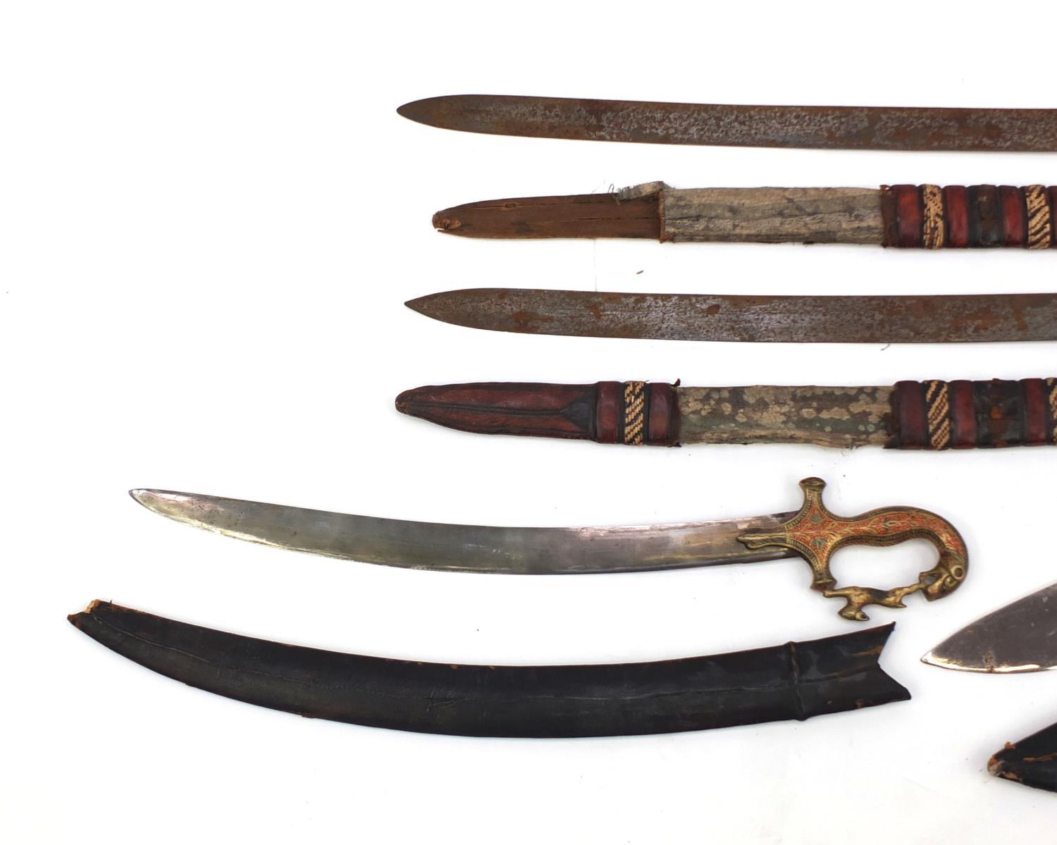 Four Middle Eastern swords including two African with part leather ...